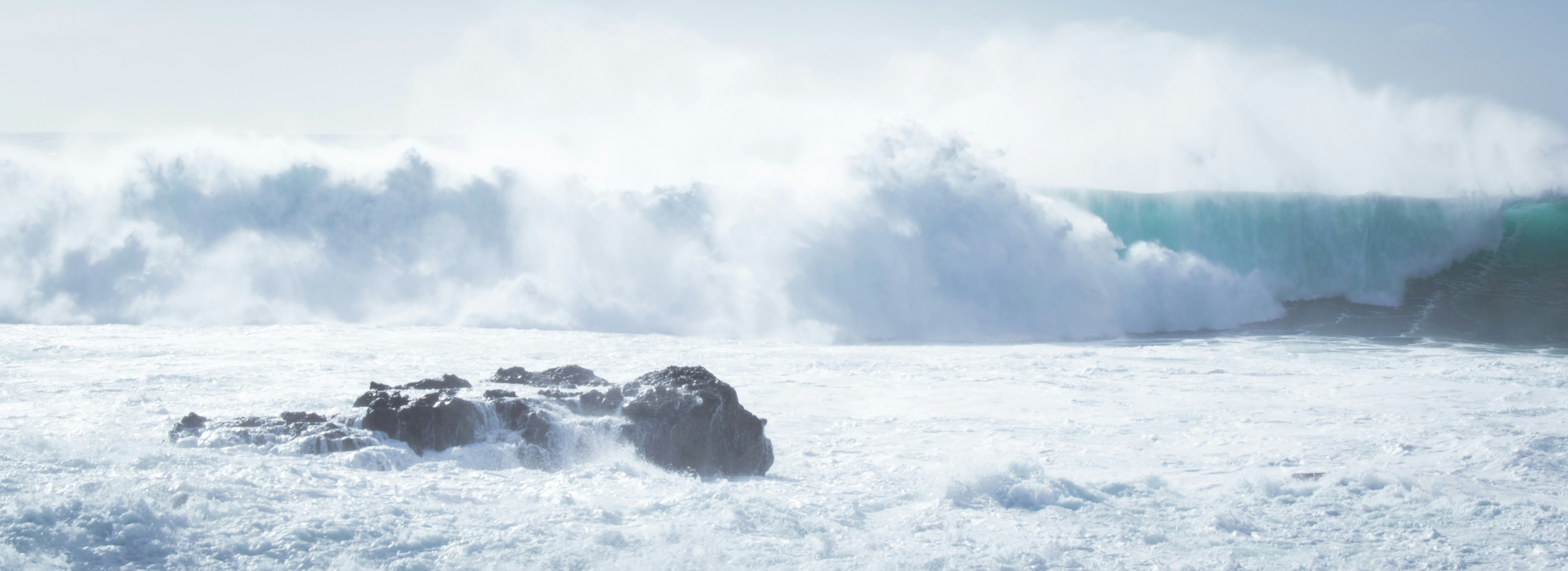 Cresting Breakers Over Ocean Foam