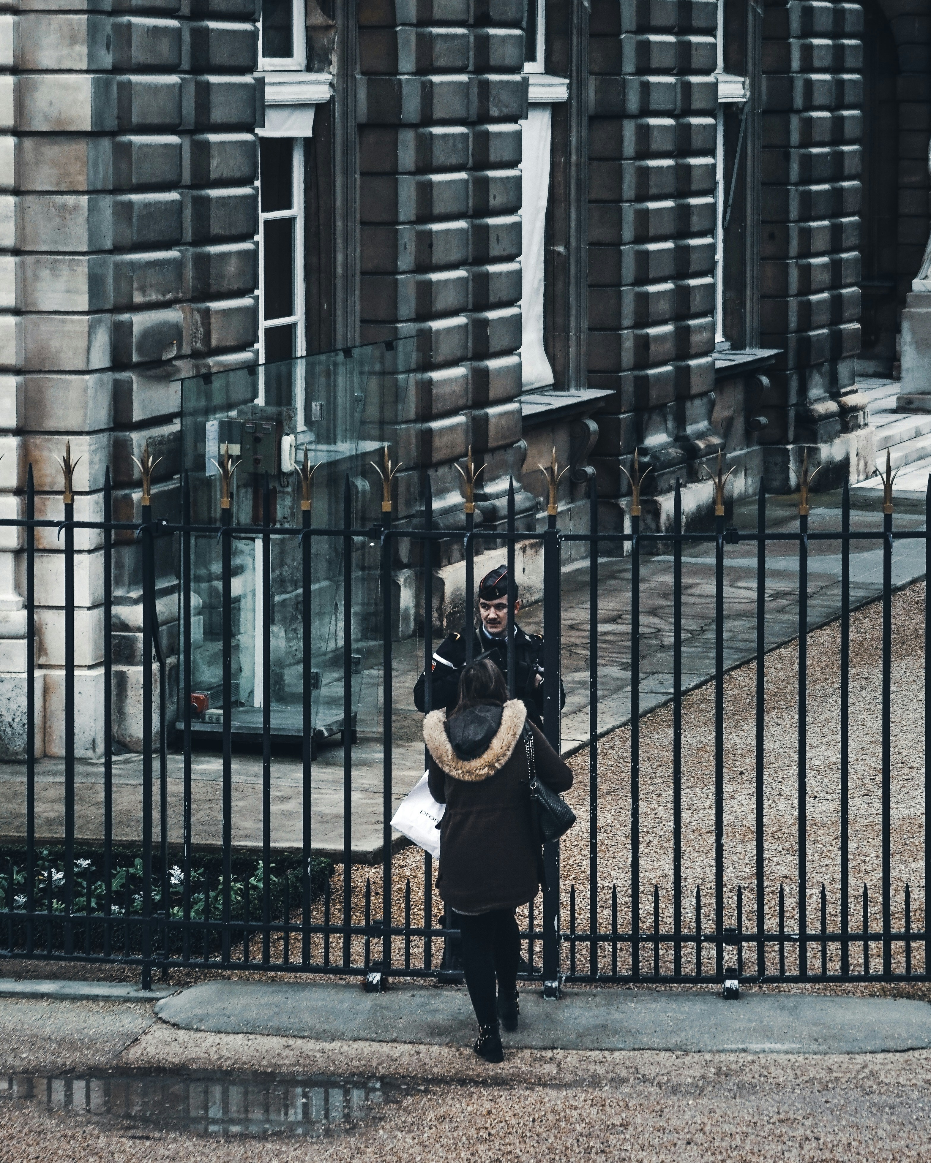 Woman talking to man behind metal gate during daytime photo – Free ...