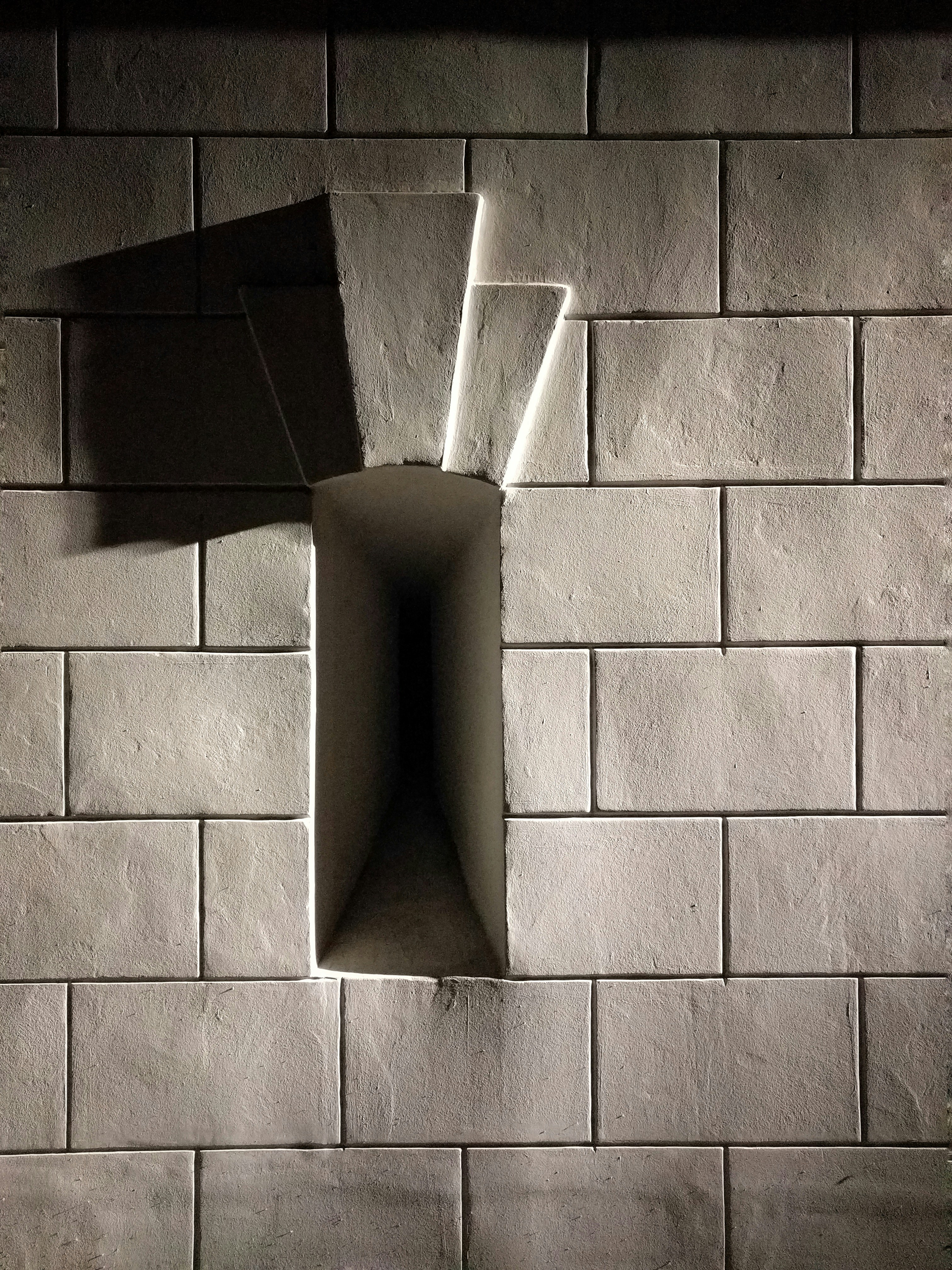 Narrow Stone Niche: Echoes of Light in a Brick Corridor