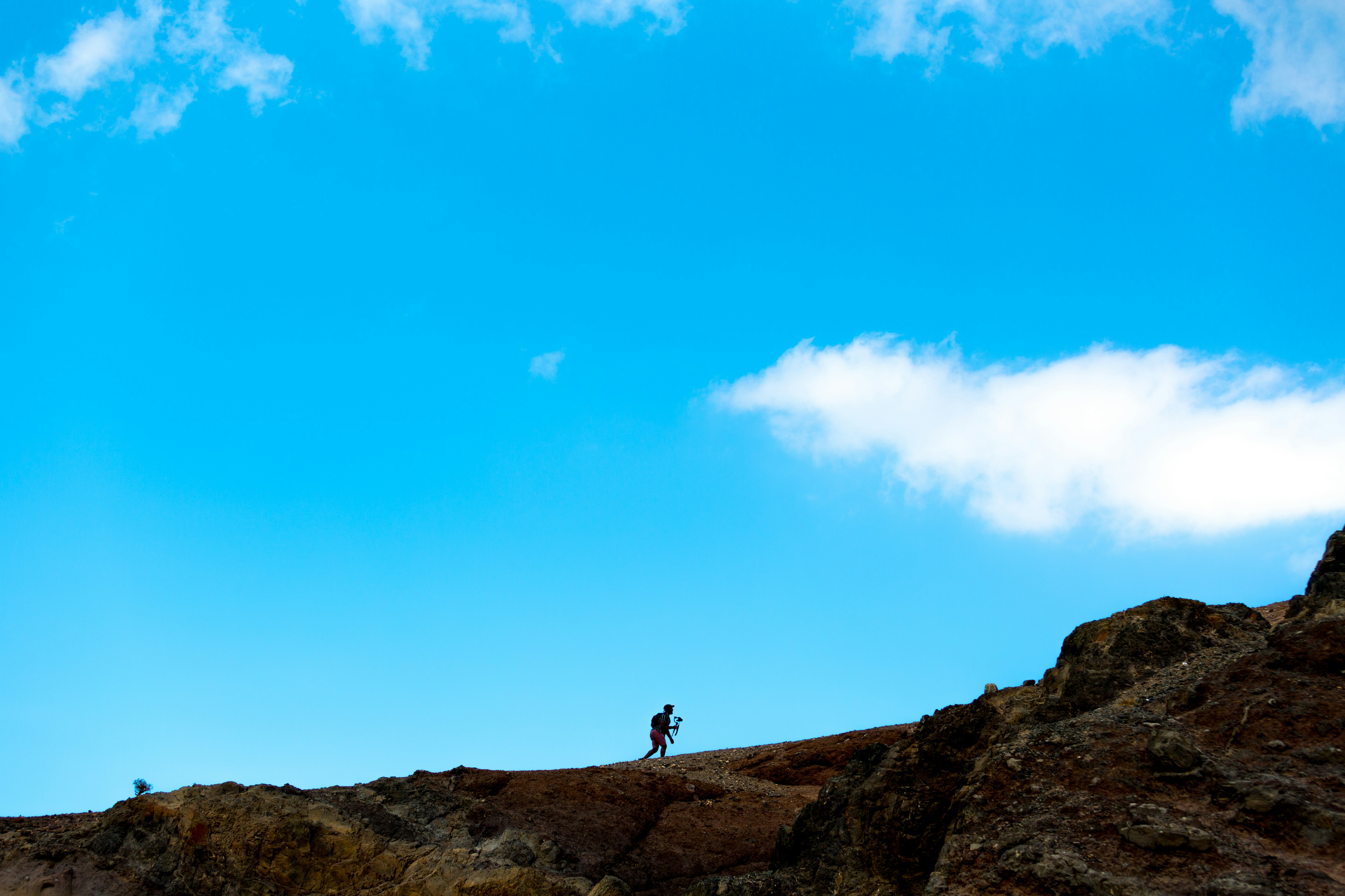 Person on incline land terrain during daytime photo – Free Blue Image ...