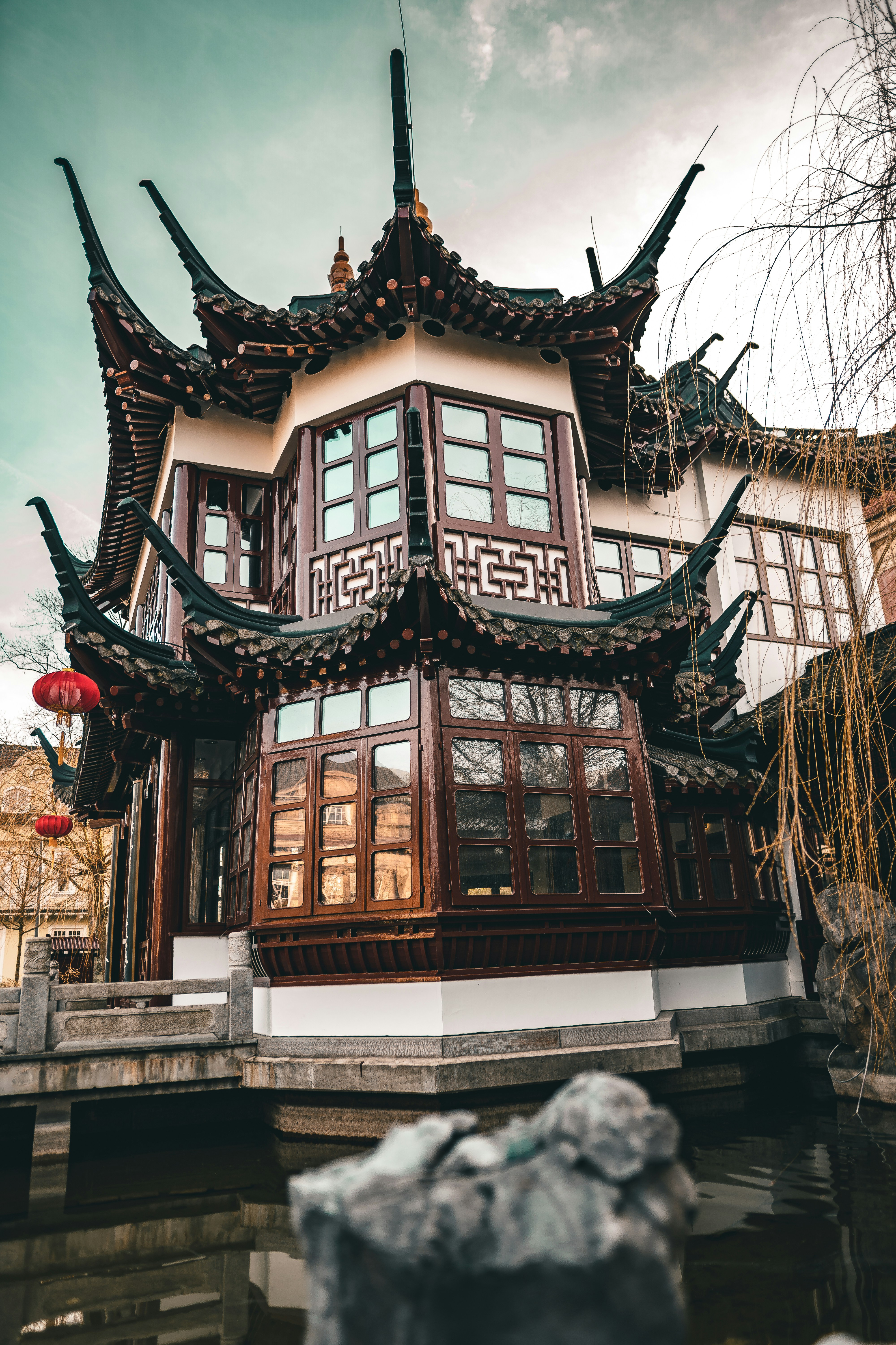 Ornate Chinese Pavilion Rising Over a Calm Canal with Lanterns