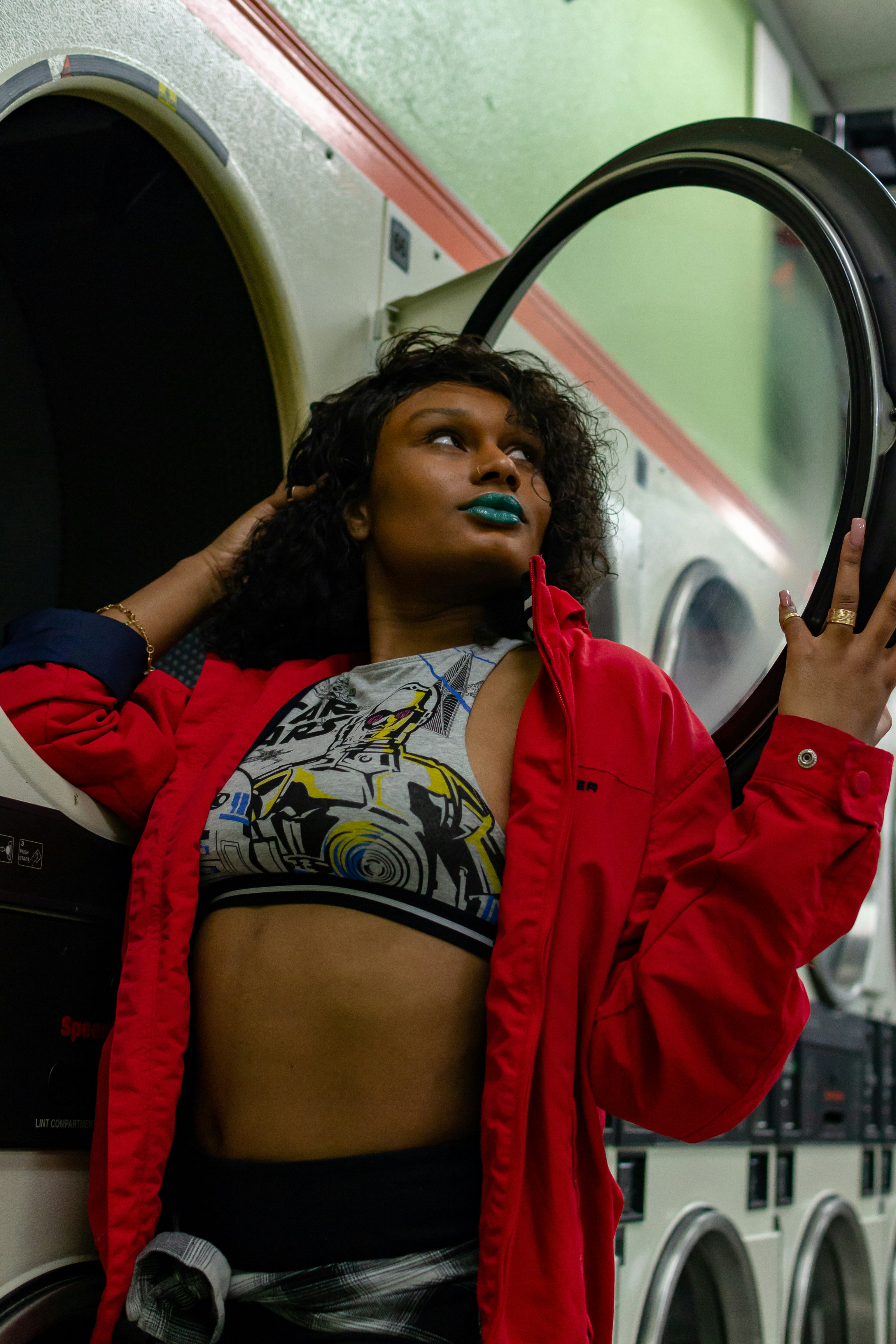 Bold Blue-Lipped Confidence in a Laundromat Portrait