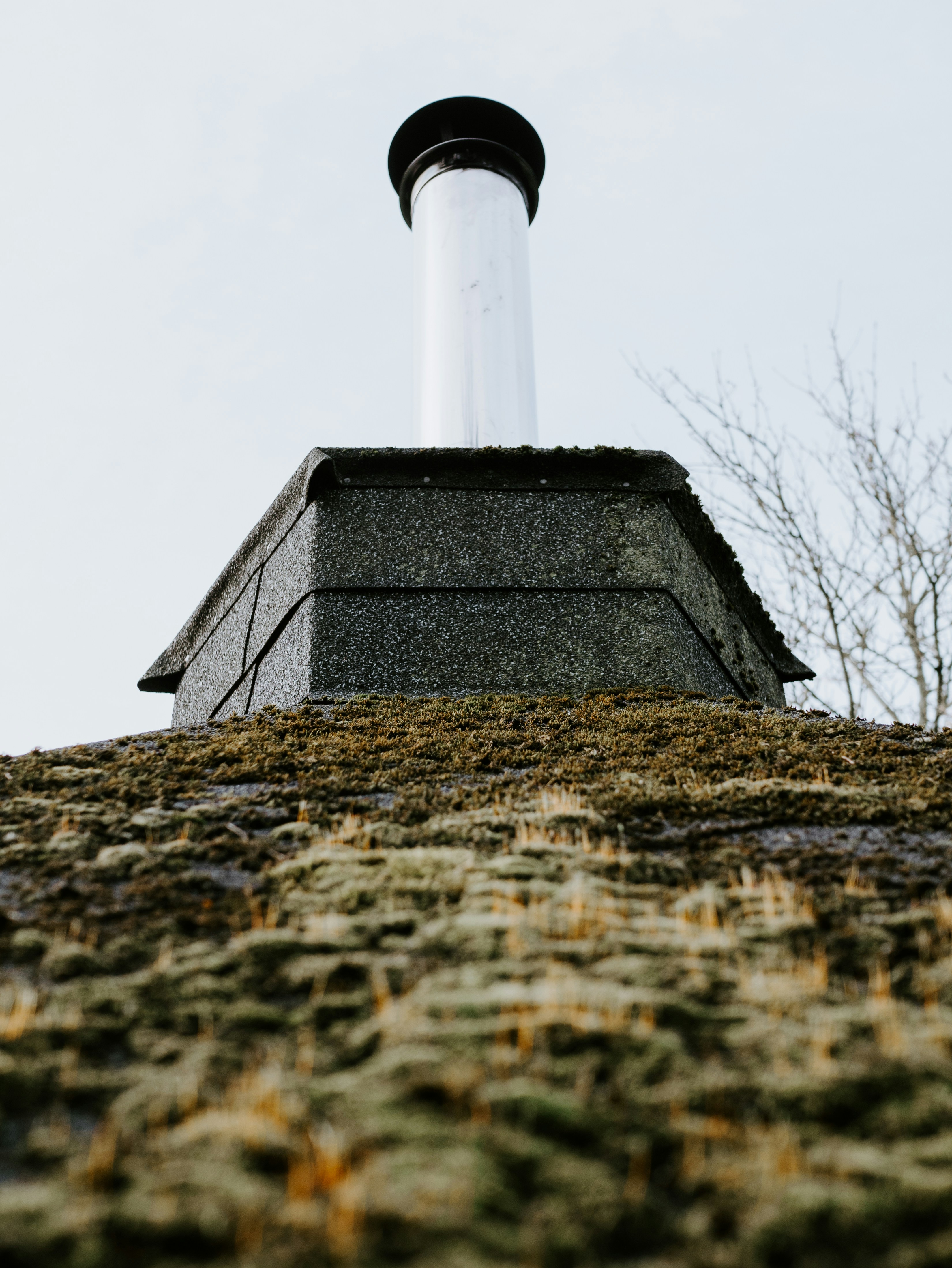 Chimney Crown: A Weathered Rooftop Speaks of Winter Sky