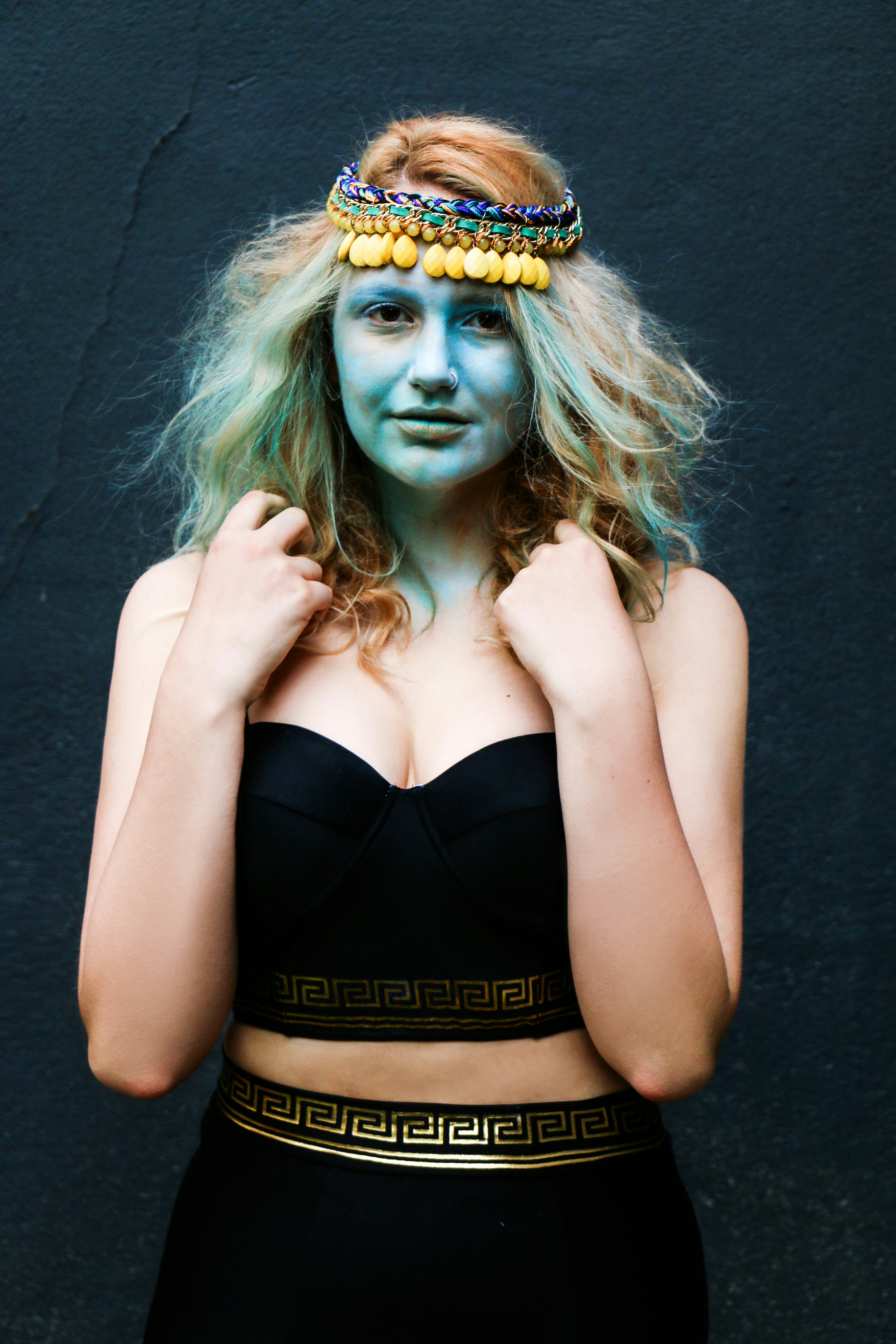 Blue-tinted gaze and golden crown: a bold portrait in navy