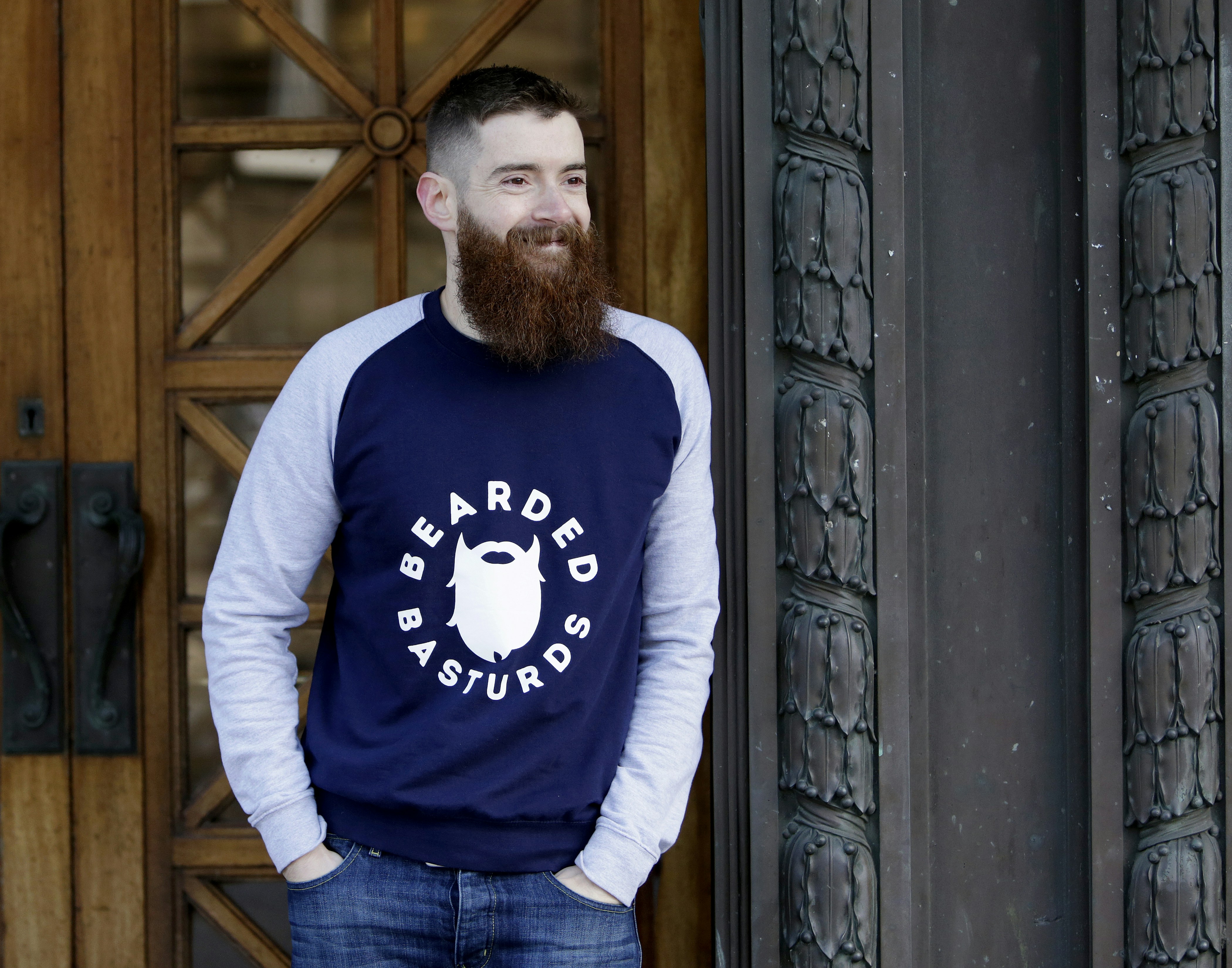 Bearded Confidence at a Doorway of Timber and Stone