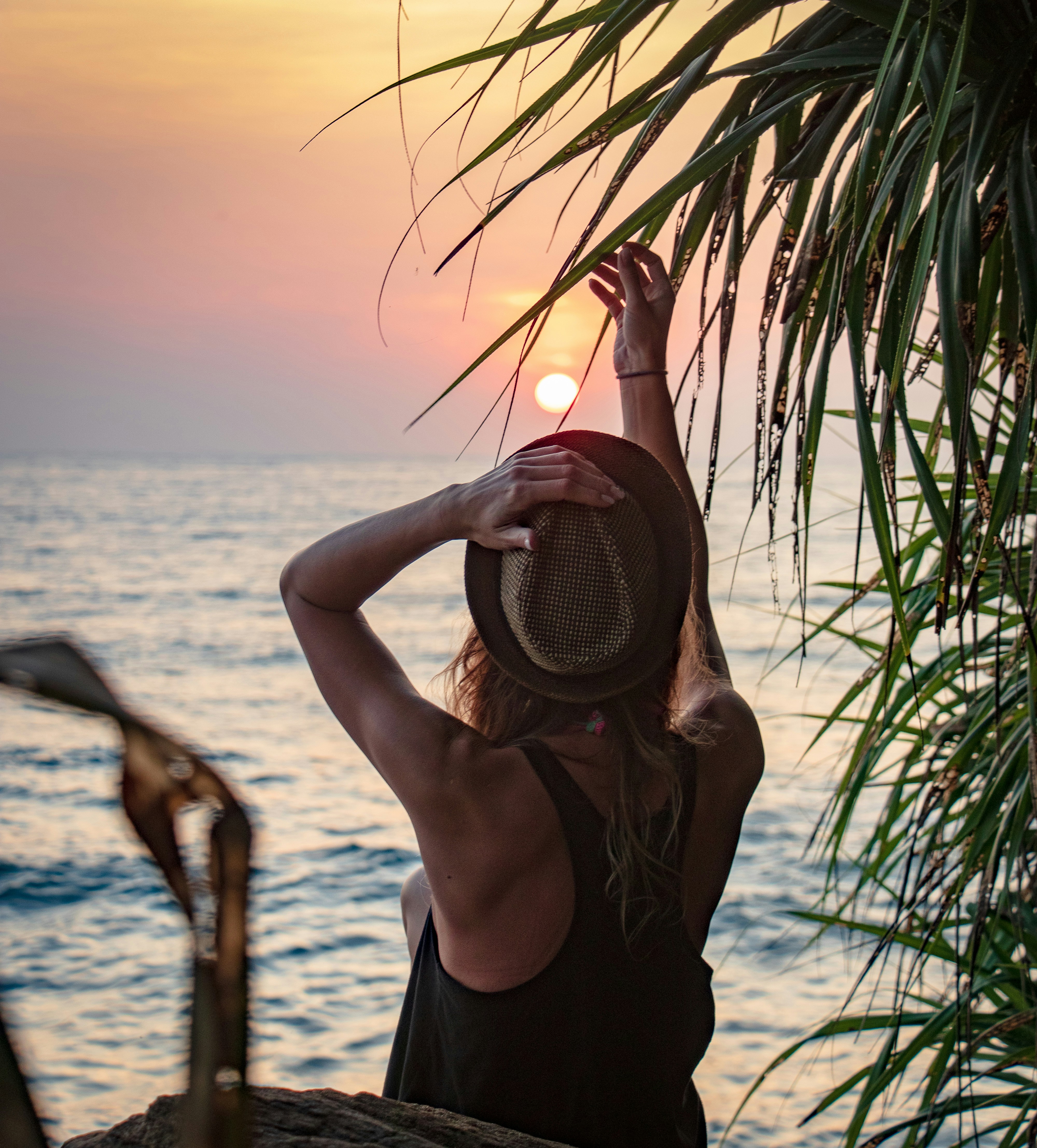 Palm-Framed Sunset Portrait by the Sea