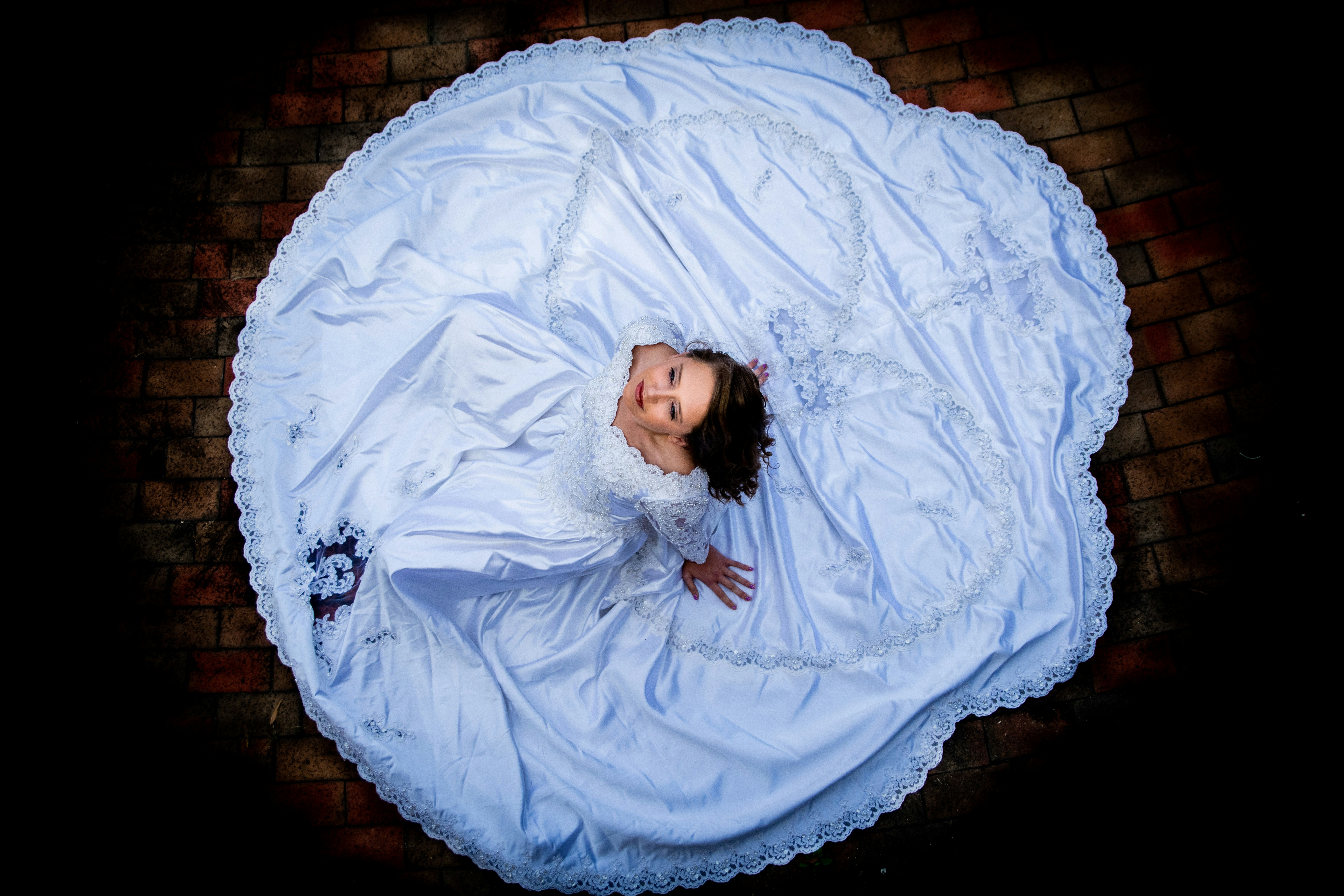 Circular Portrait: A Woman in a Delicate White Gown Embracing the Floor Tile Frame