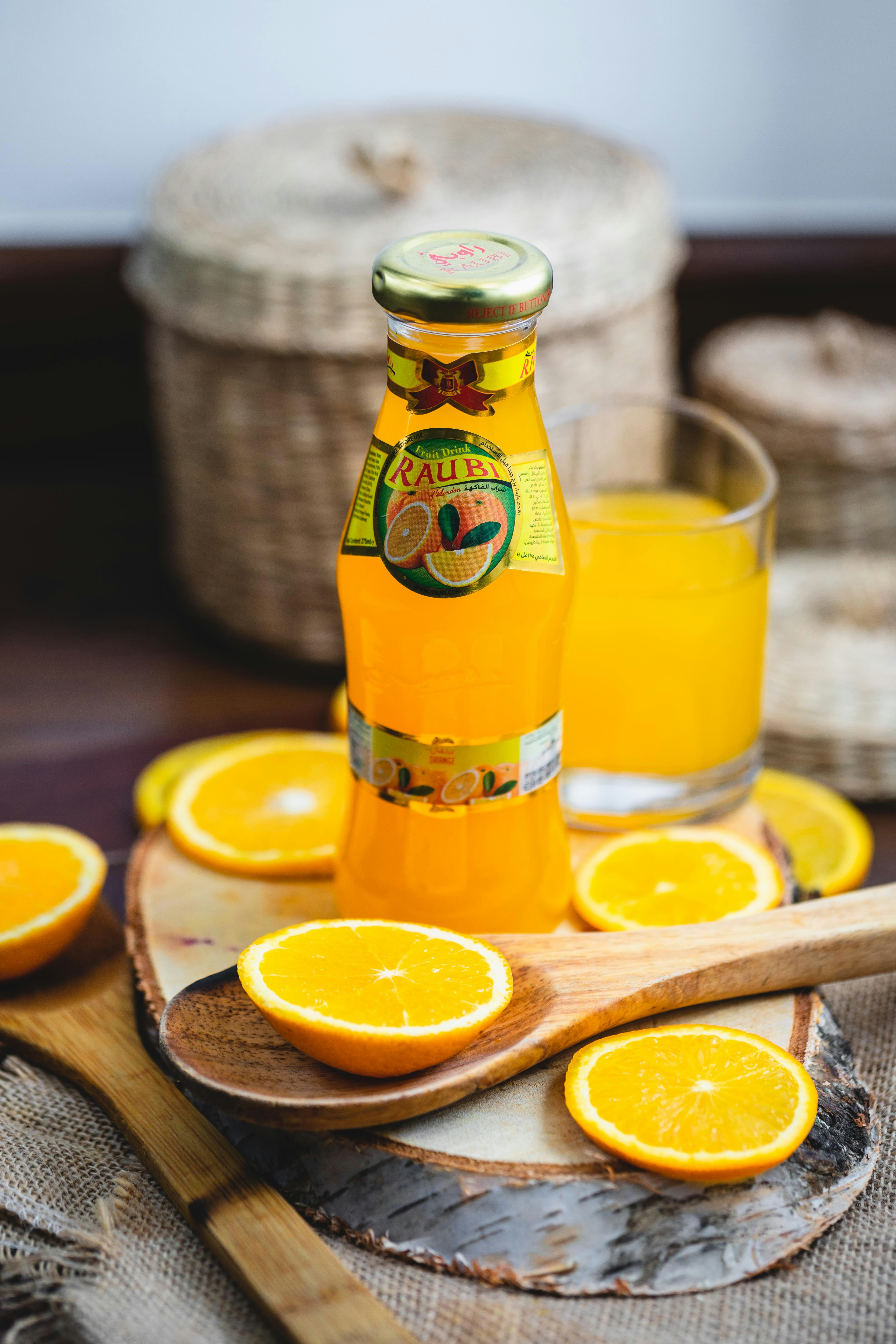 Centerstage Citrus: The Orange Juice Bottle Amid Sliced Halves