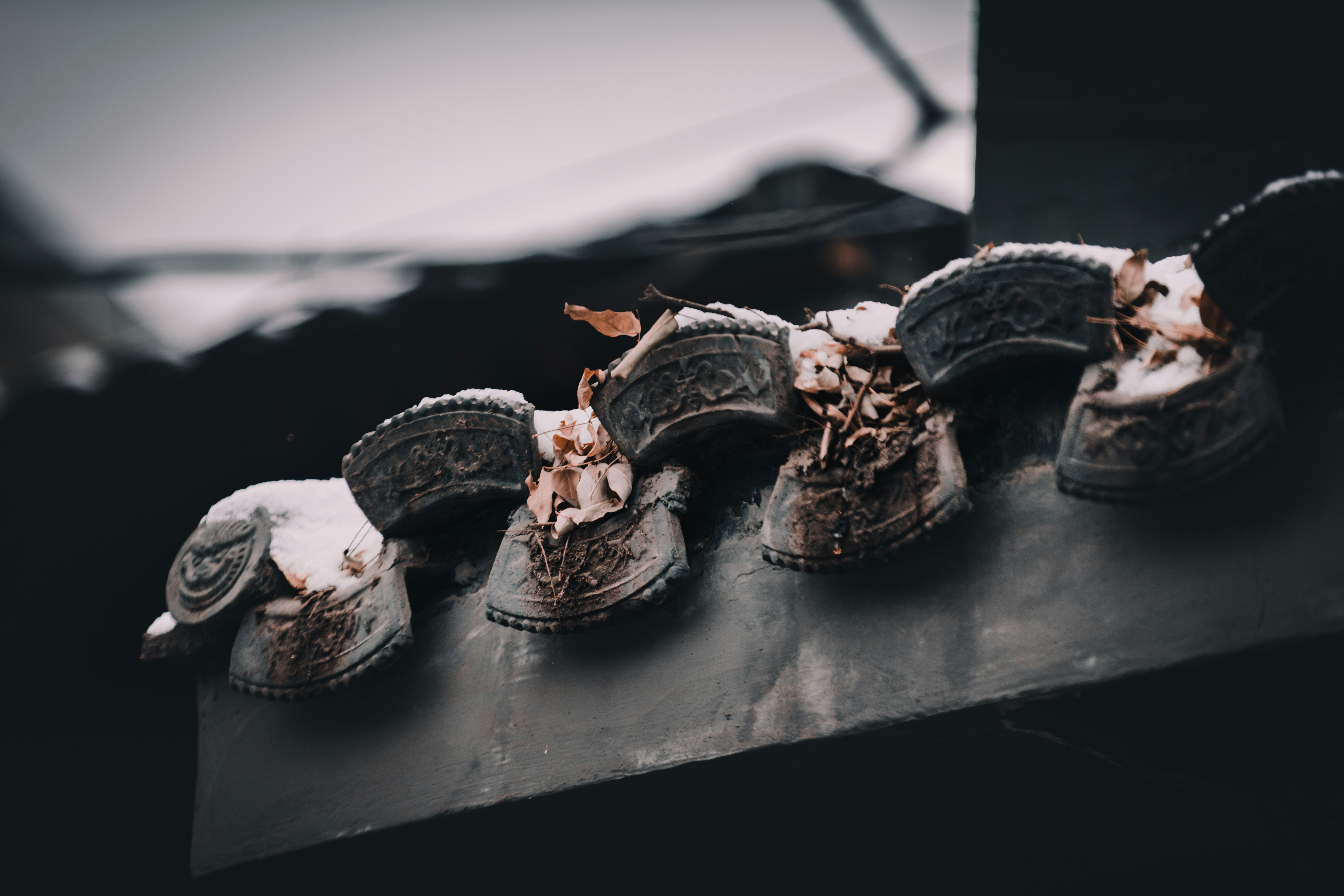 a row of worn shoes sitting on top of a metal shelf