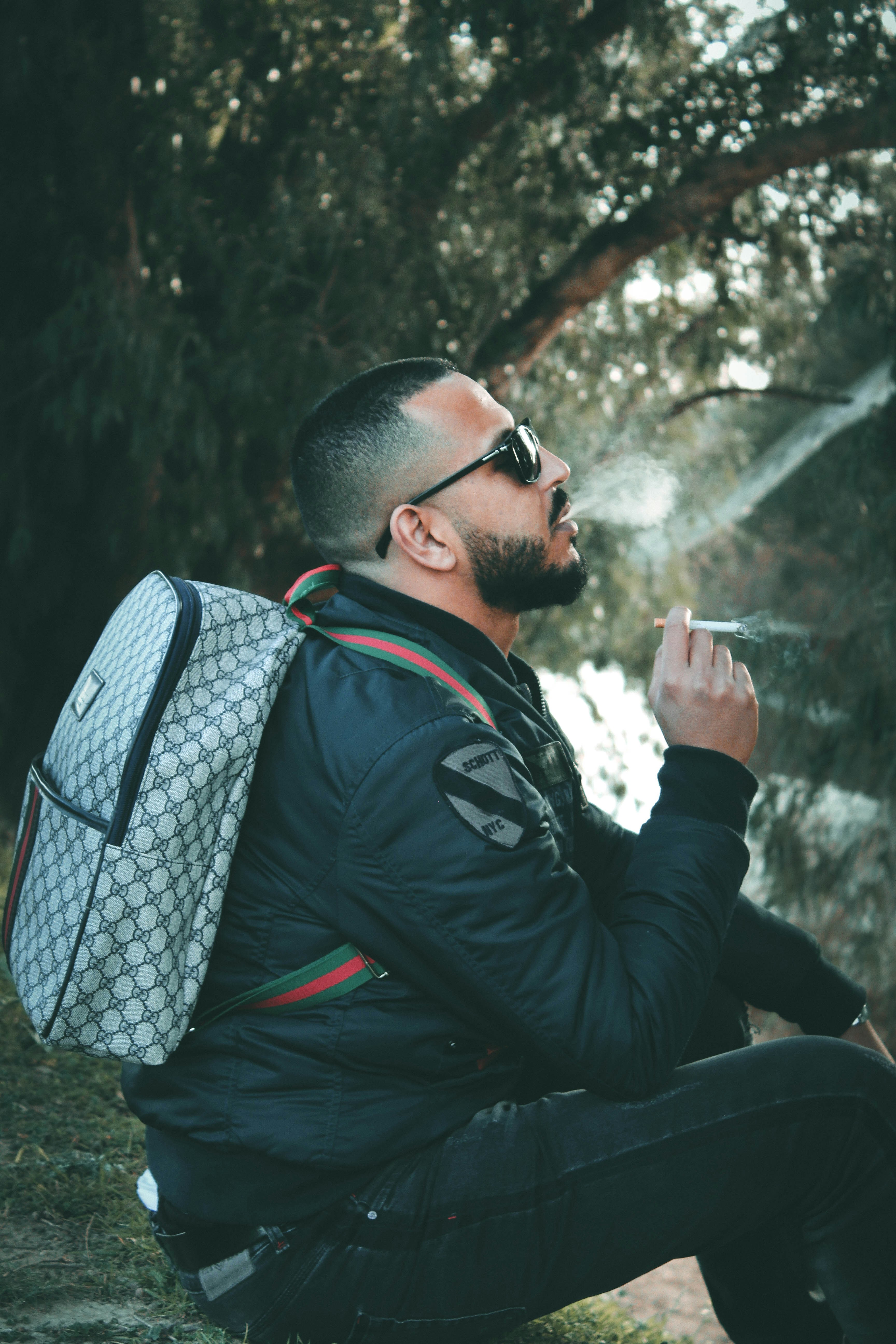Man wearing black leather jacking while smoking photo – Free Man Image ...
