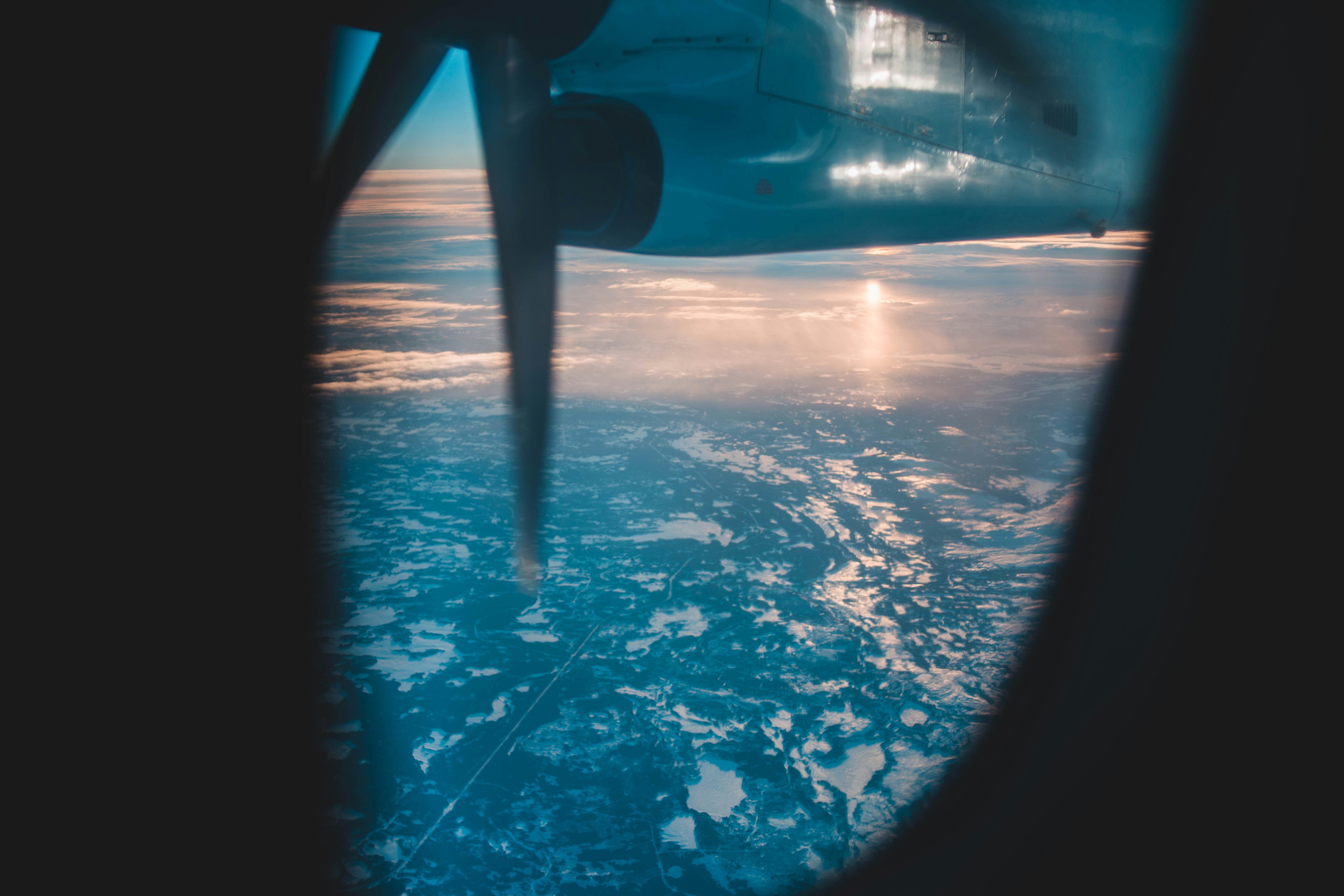 Polar Twilight Window View: Ice-Sea and Wing in a Sunset Horizon