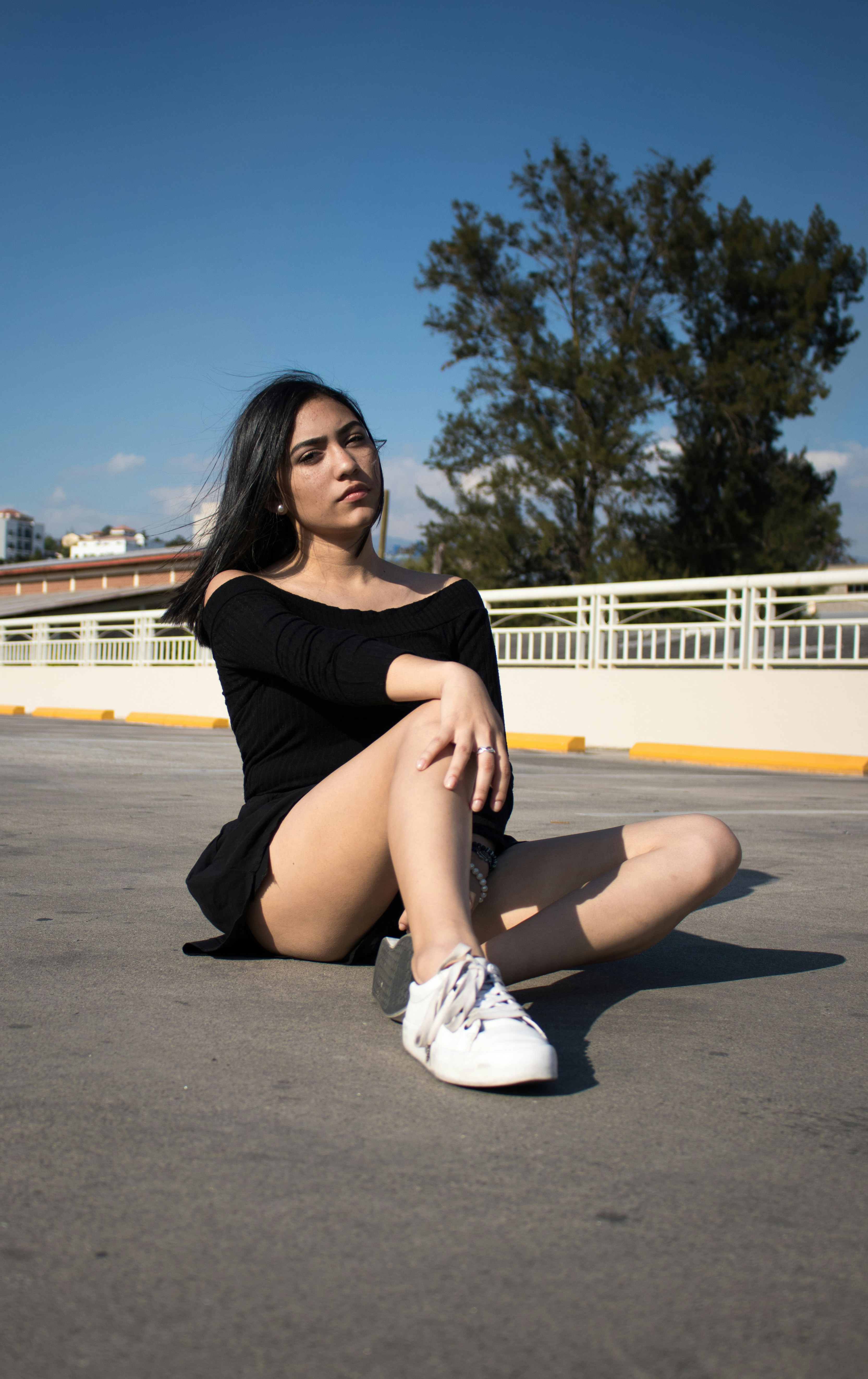 Woman in black dress sitting on the pavement photo – Free Portrait ...