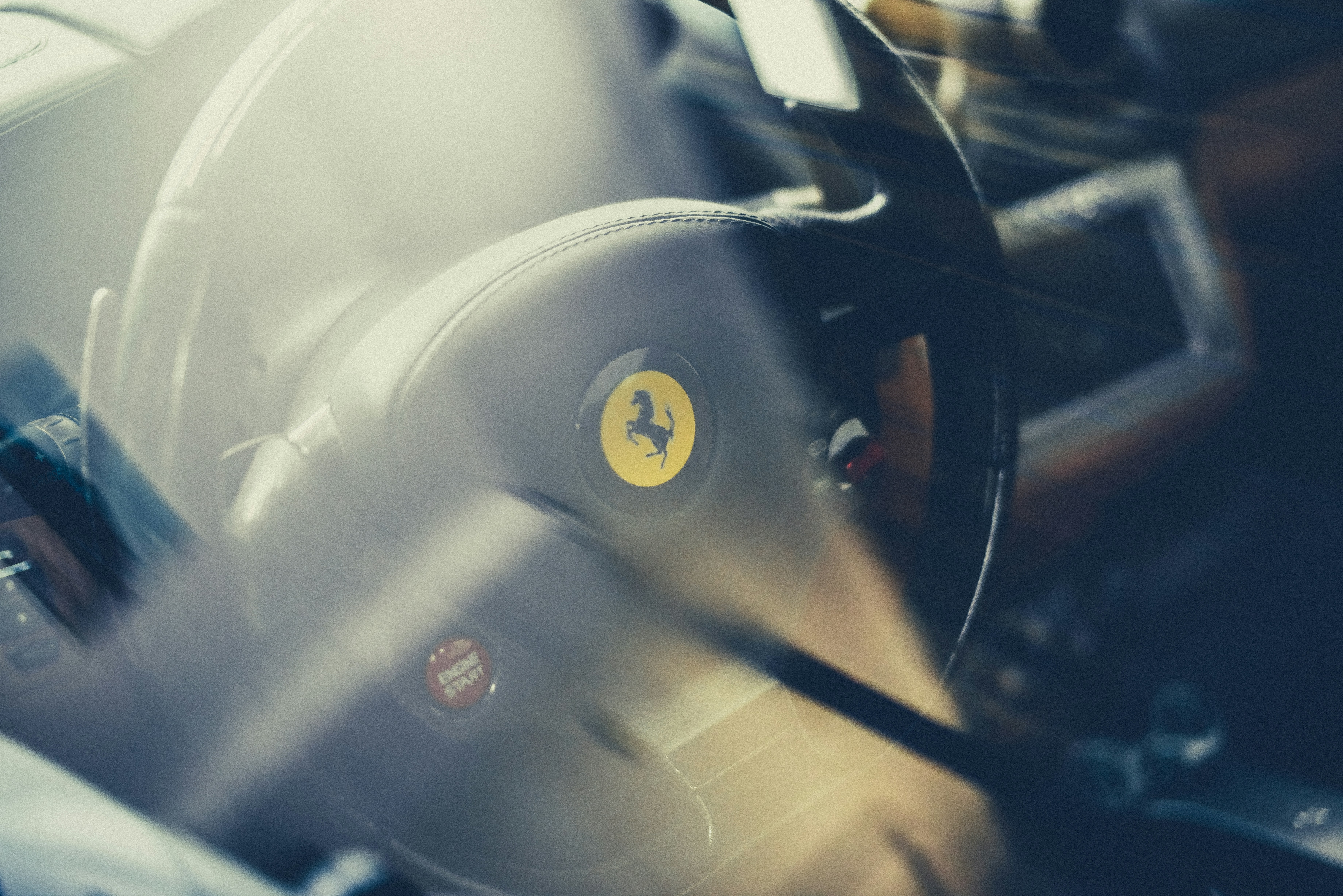 Ferrari Steering Wheel in Soft Focus: A Glimpse Into the Cockpit