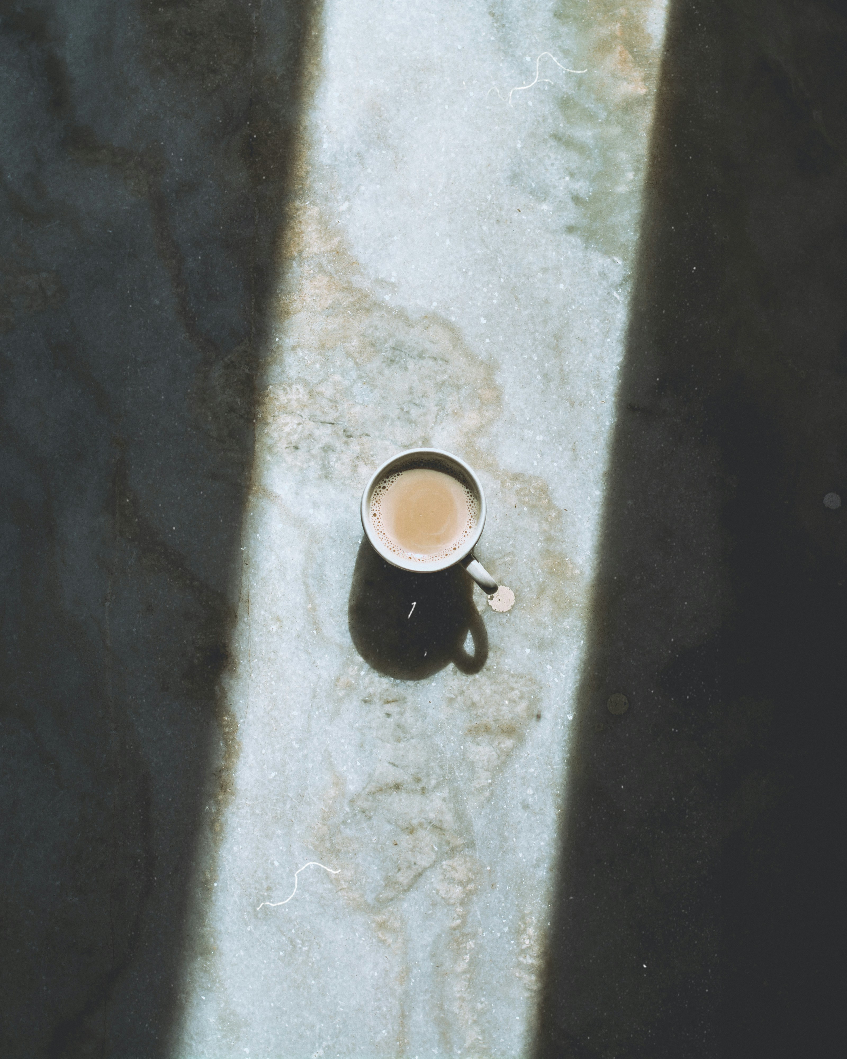 grey ceramic mug on grey surface