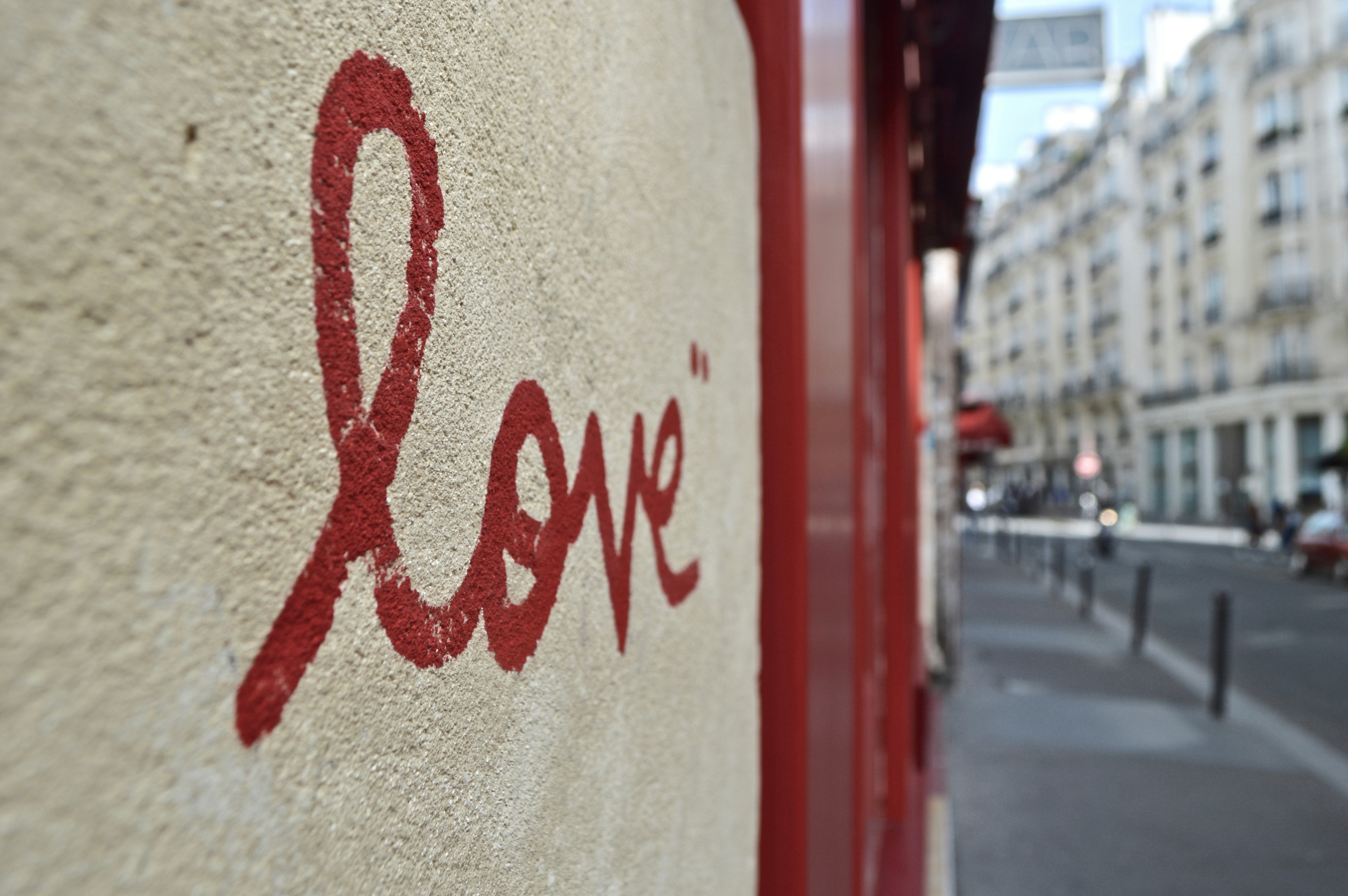 Red Love print on wall photo – Free Brown Image on Unsplash