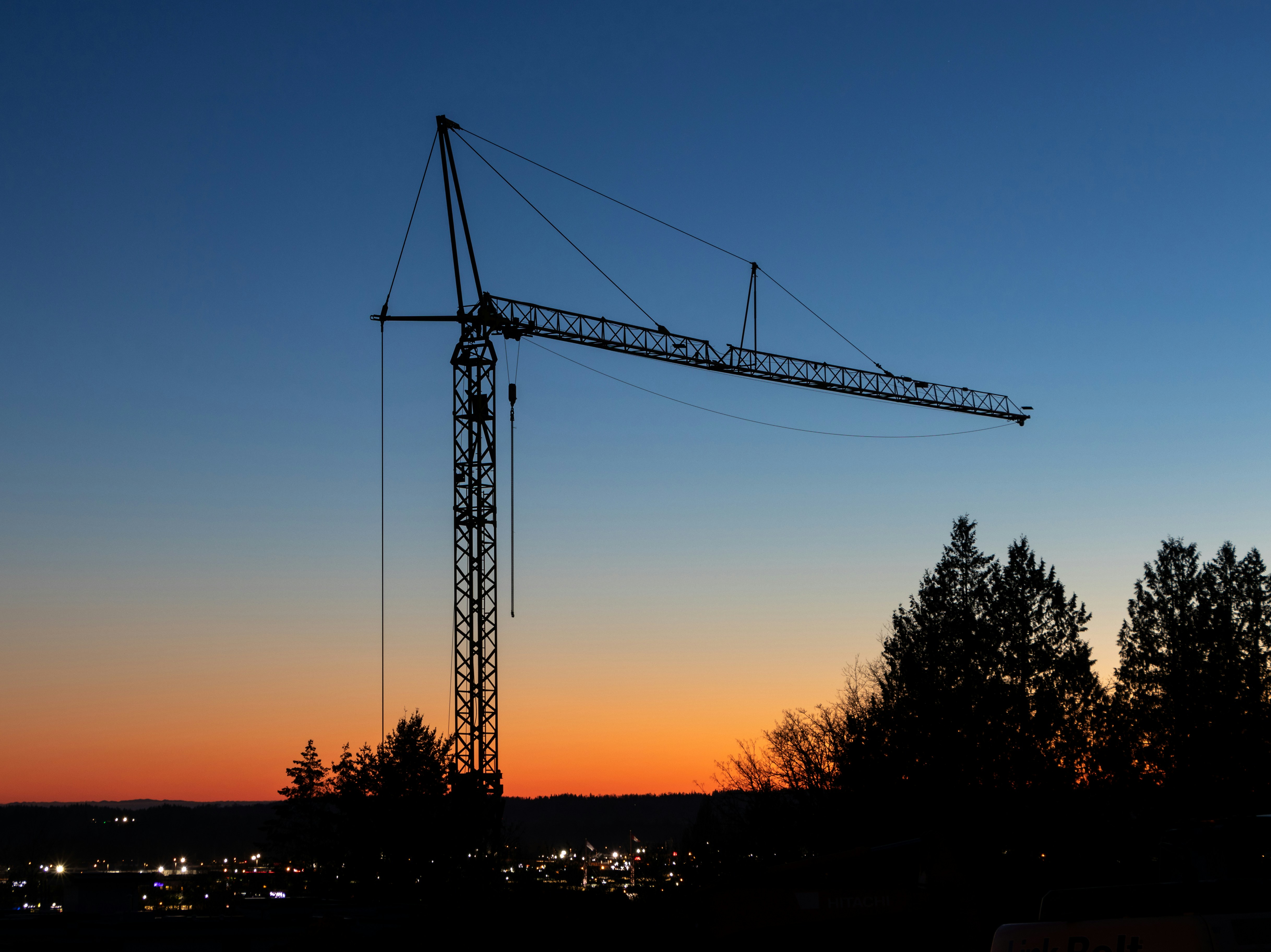 Horizon Stitcher: Twilight Crane Silhouette Over a Quiet City