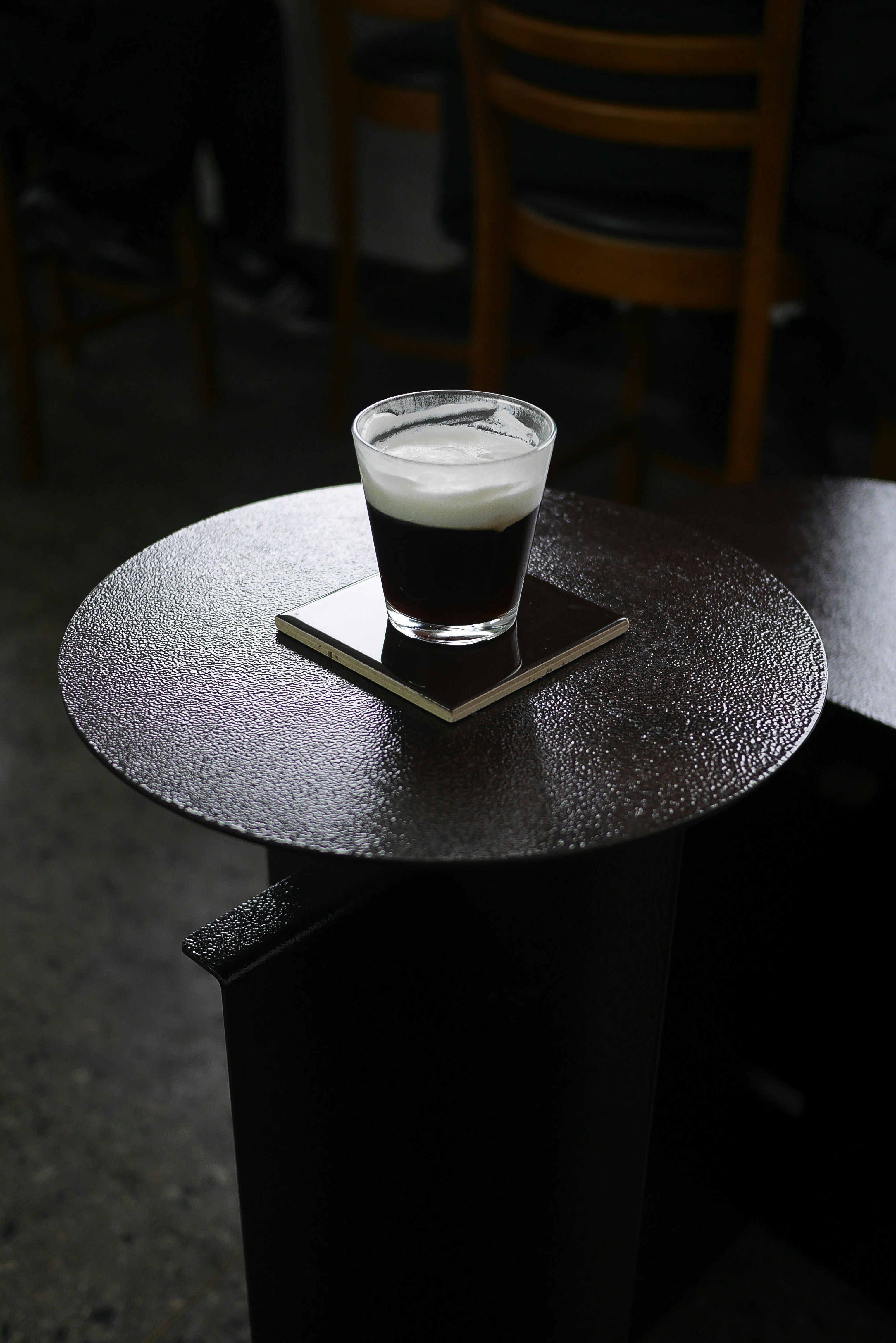 A Quiet Moment: Stout Coffee on a Textured Bar Table