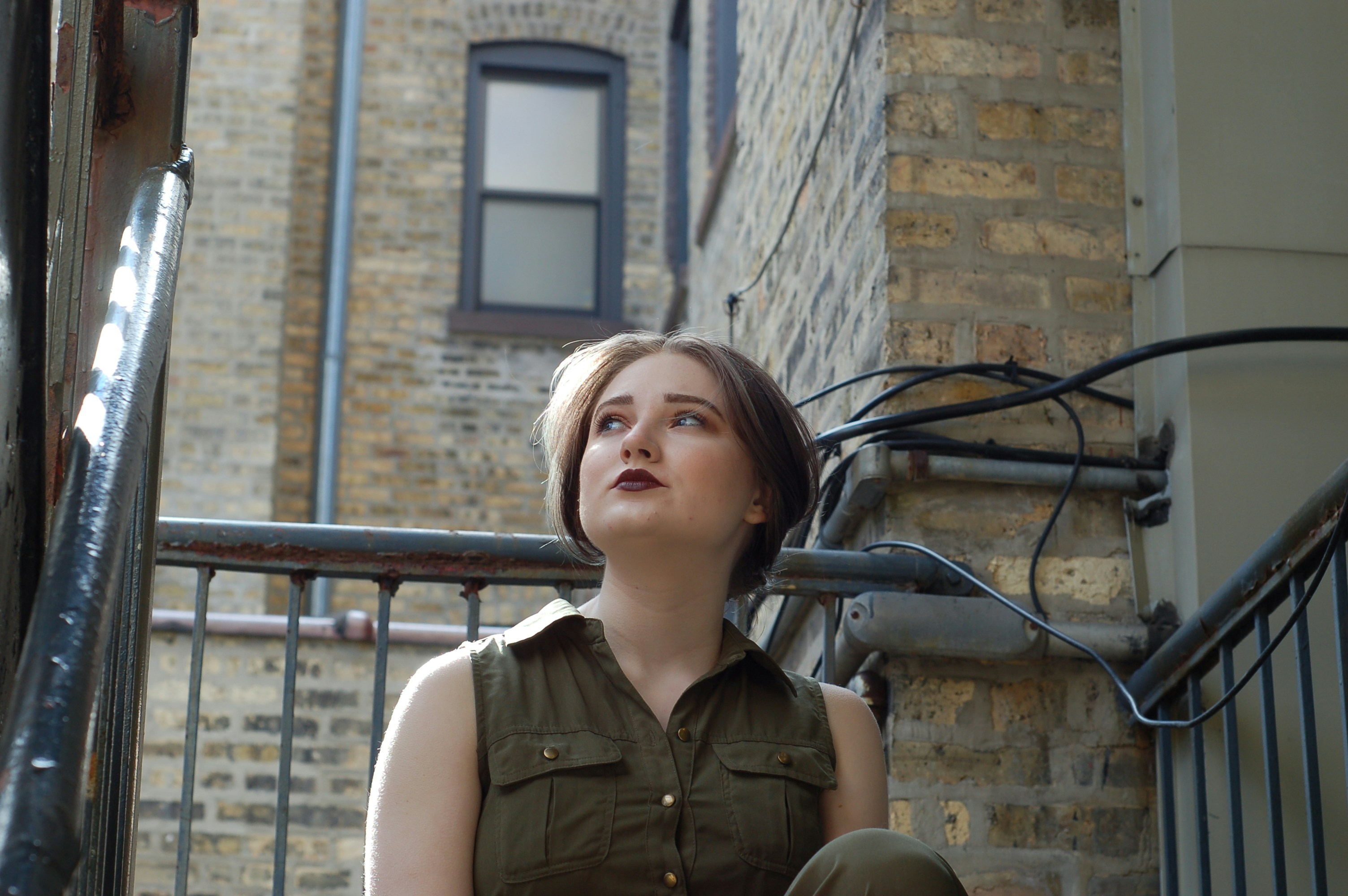 Gaze Between Cables: Portrait on a Brick Stairwell