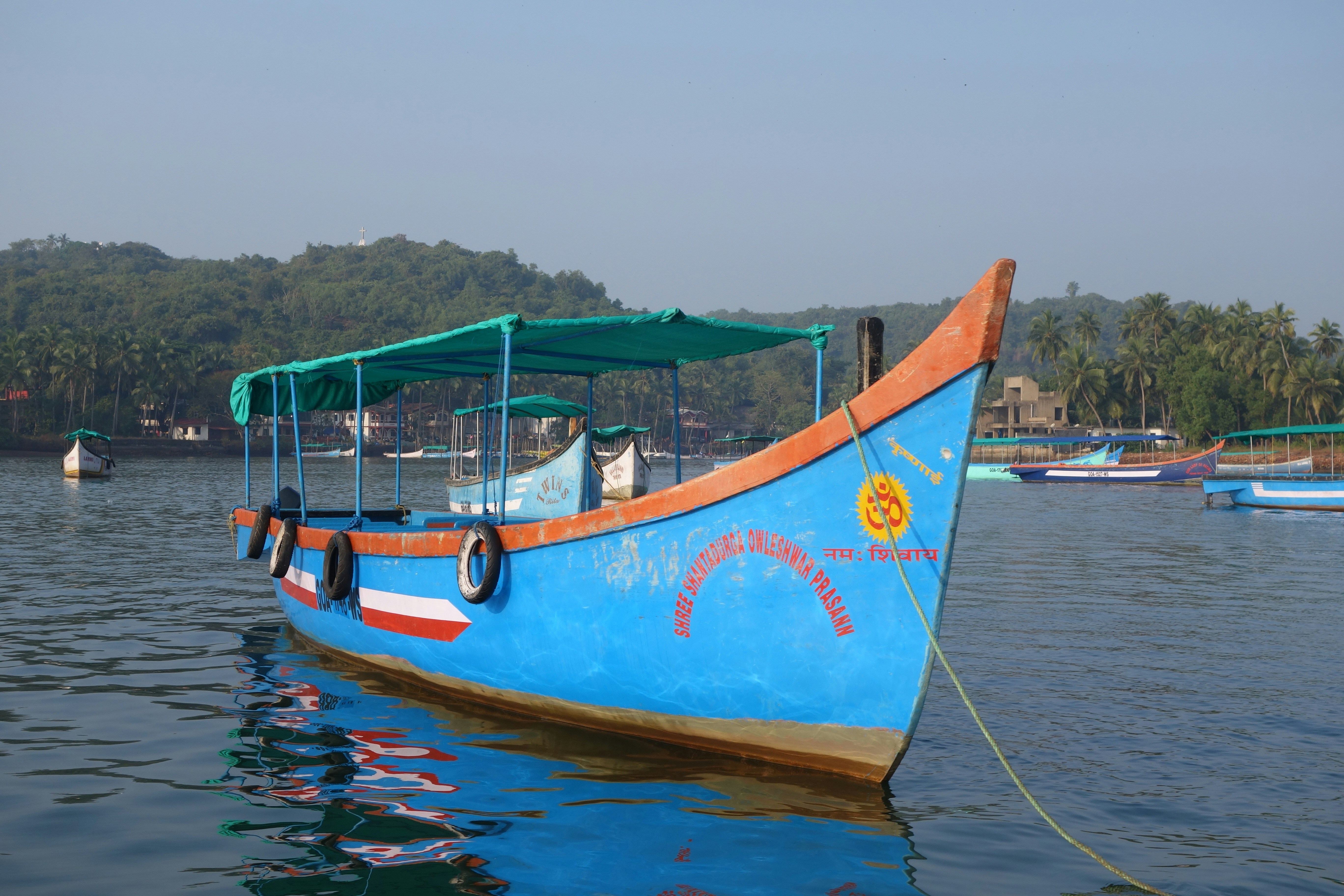 blue and orange boat on dock