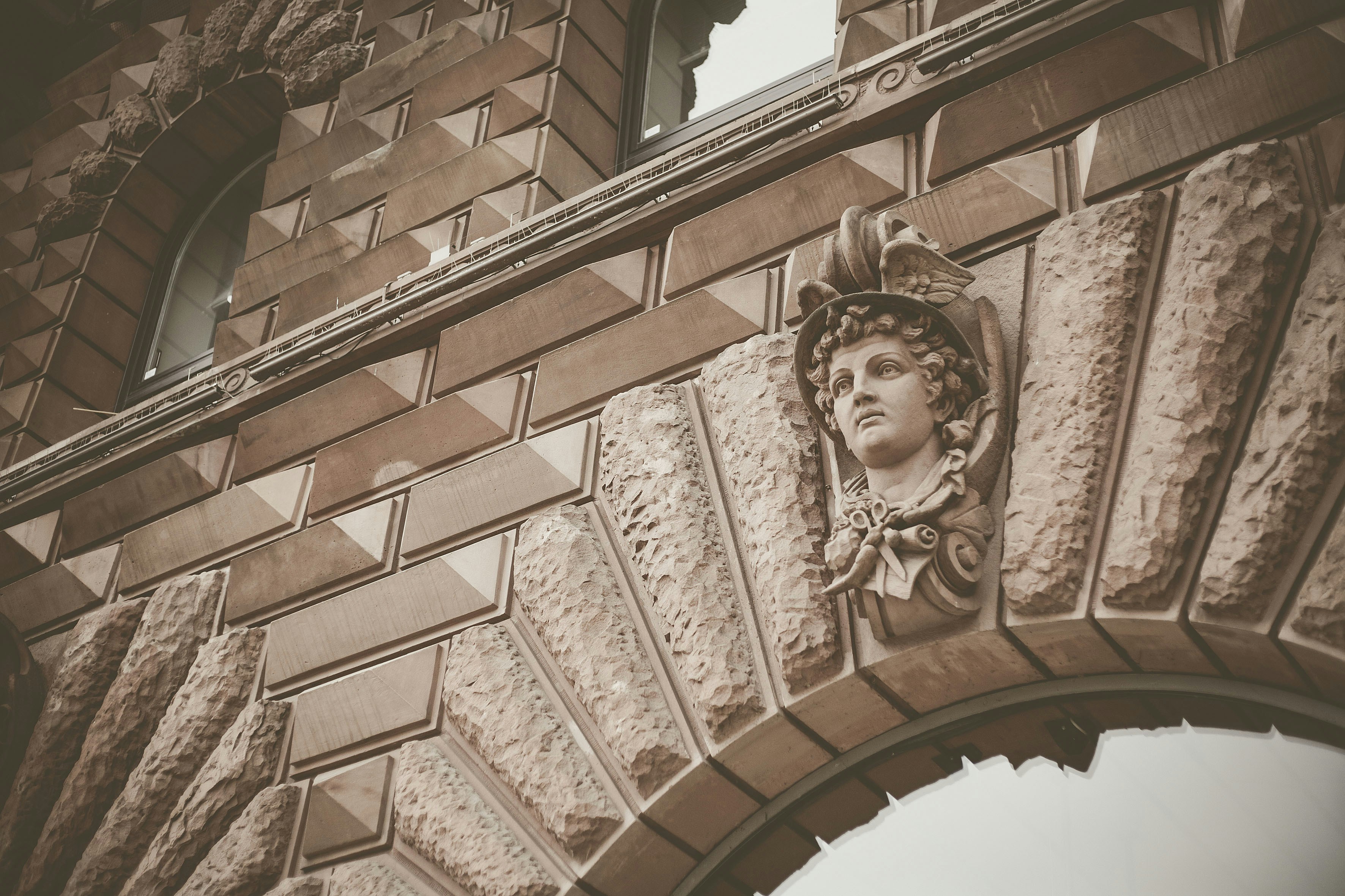 View of arch with human face statue photo – Free Brown Image on Unsplash