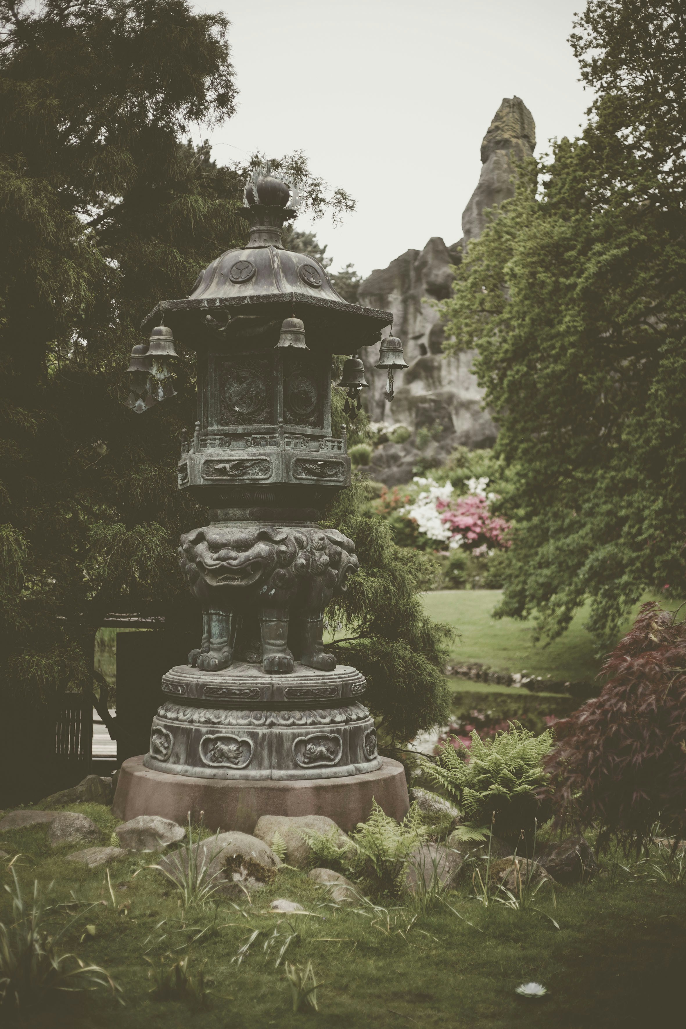 Ornate Stone Lantern Framing a Distant Rock Pinnacle in a Tranquil Garden