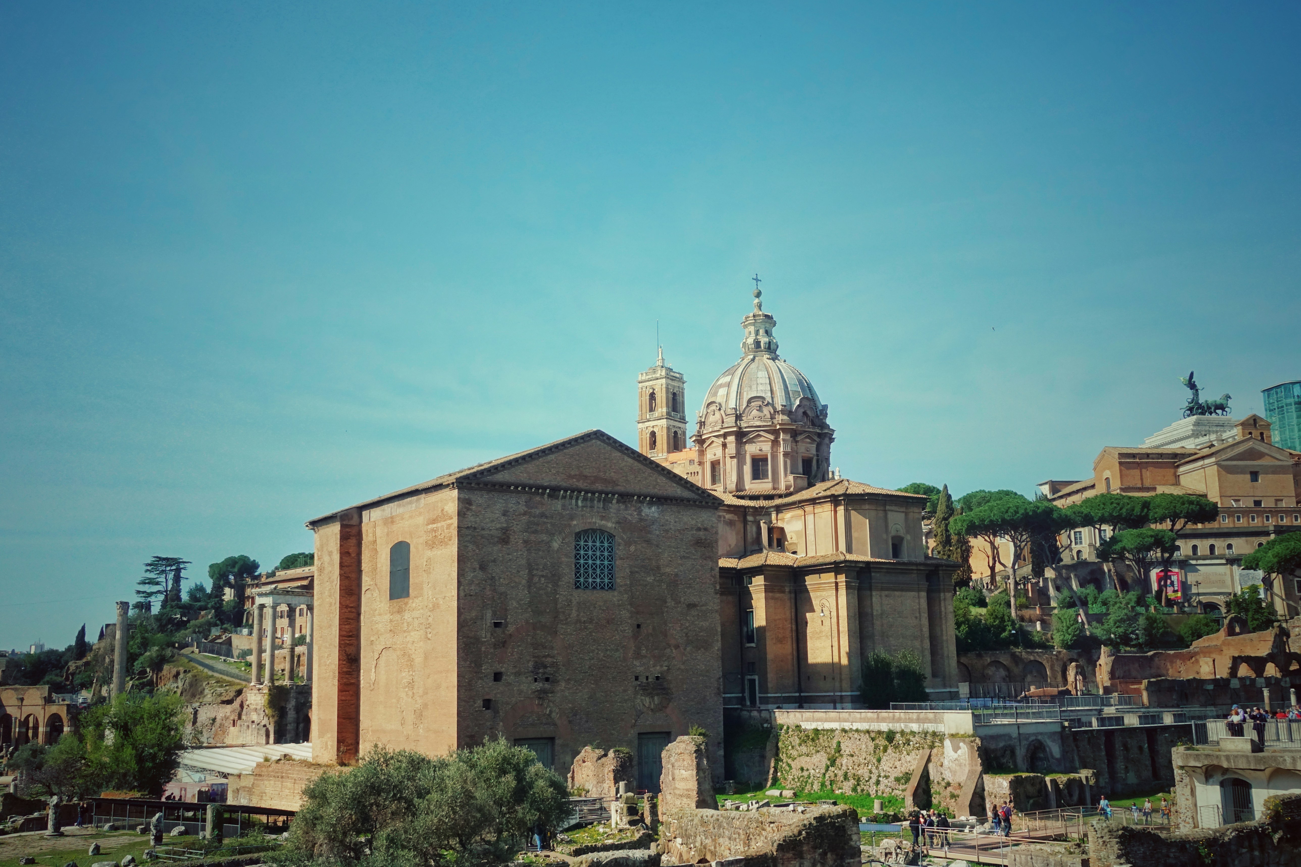 Historic cathedral with intricate domes under a clear blue sky.