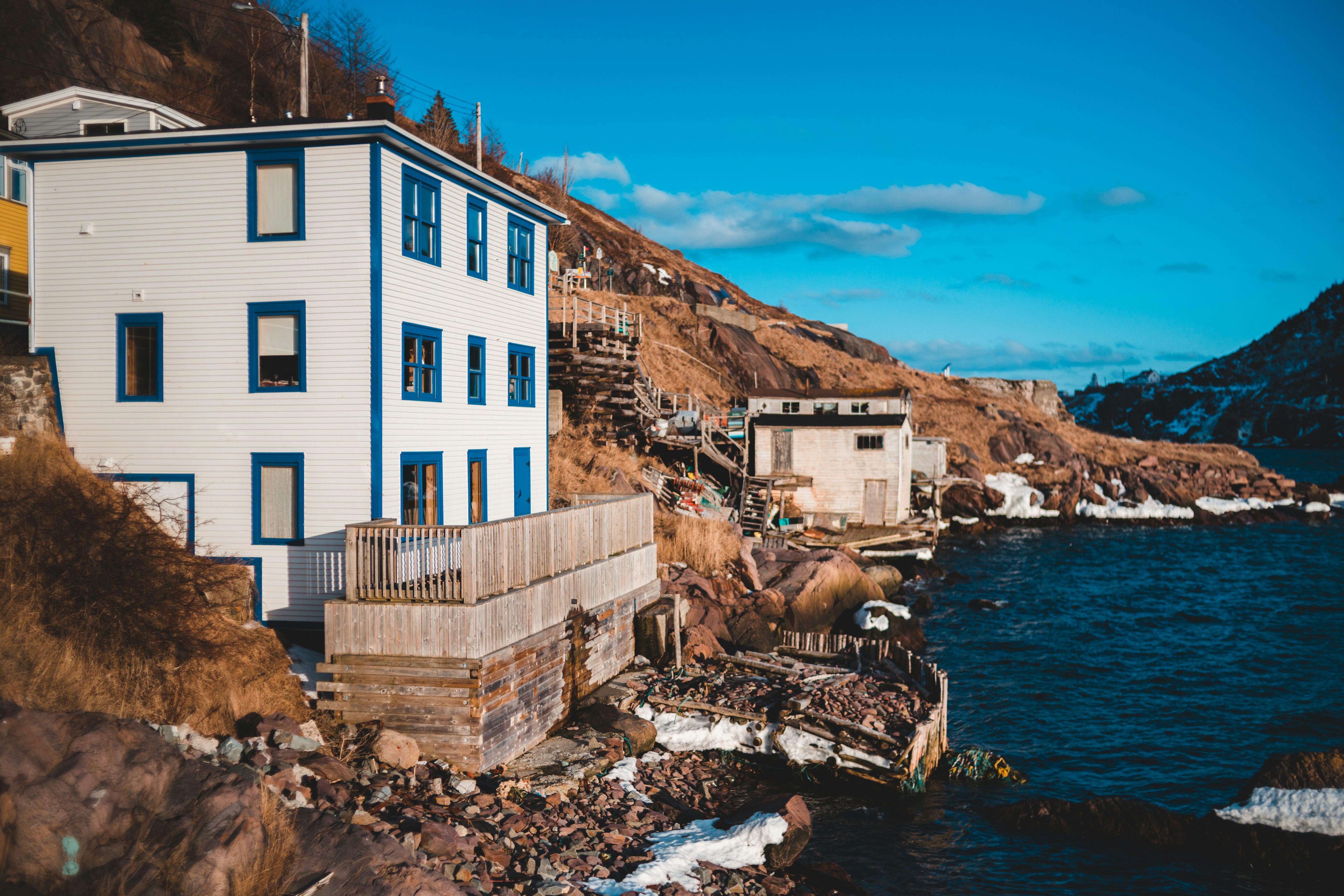 White 3-storey building beside sea photo – Free Housing Image on Unsplash