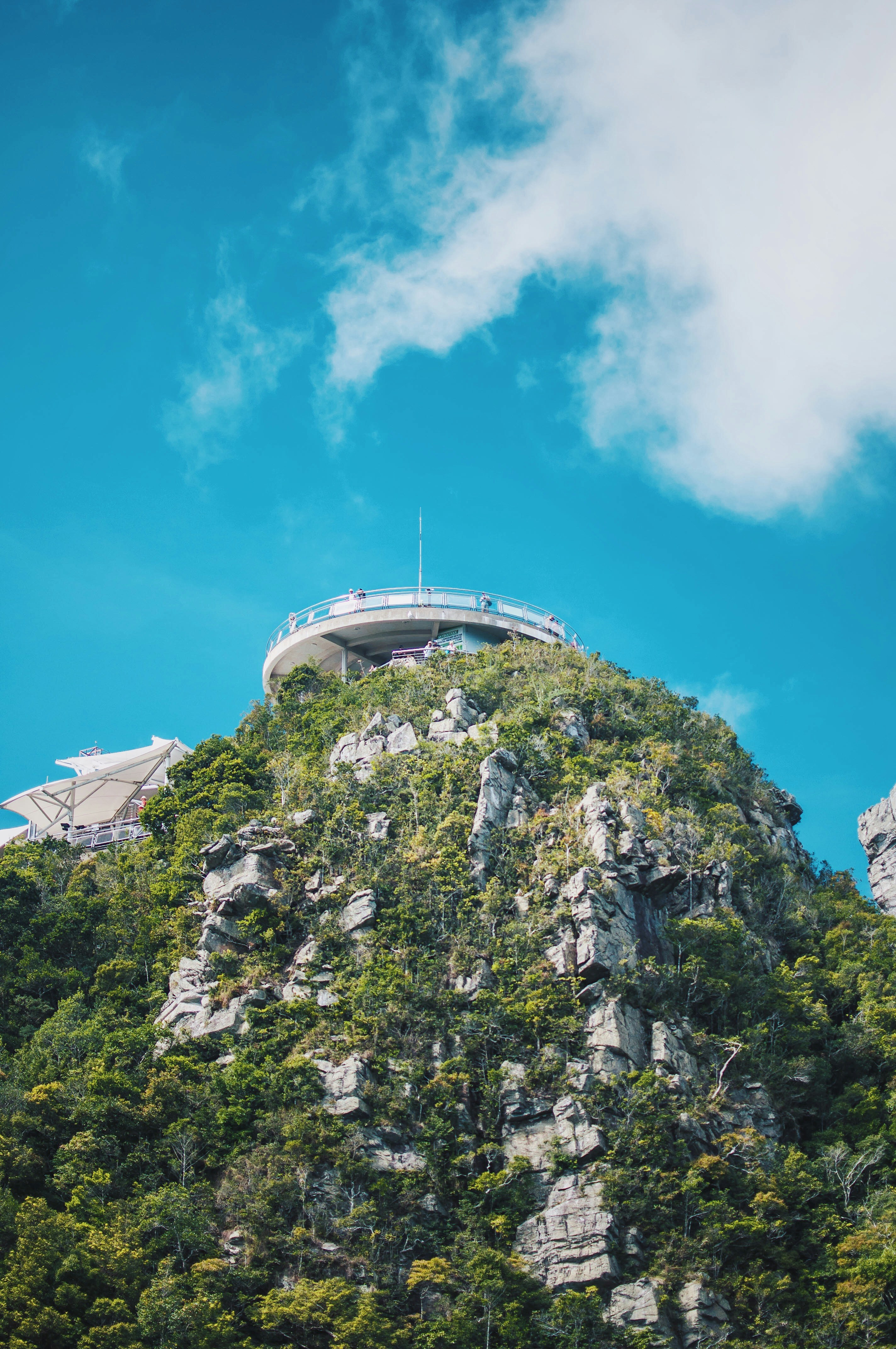 building on top of rock formation photo – Free Blue Image on Unsplash