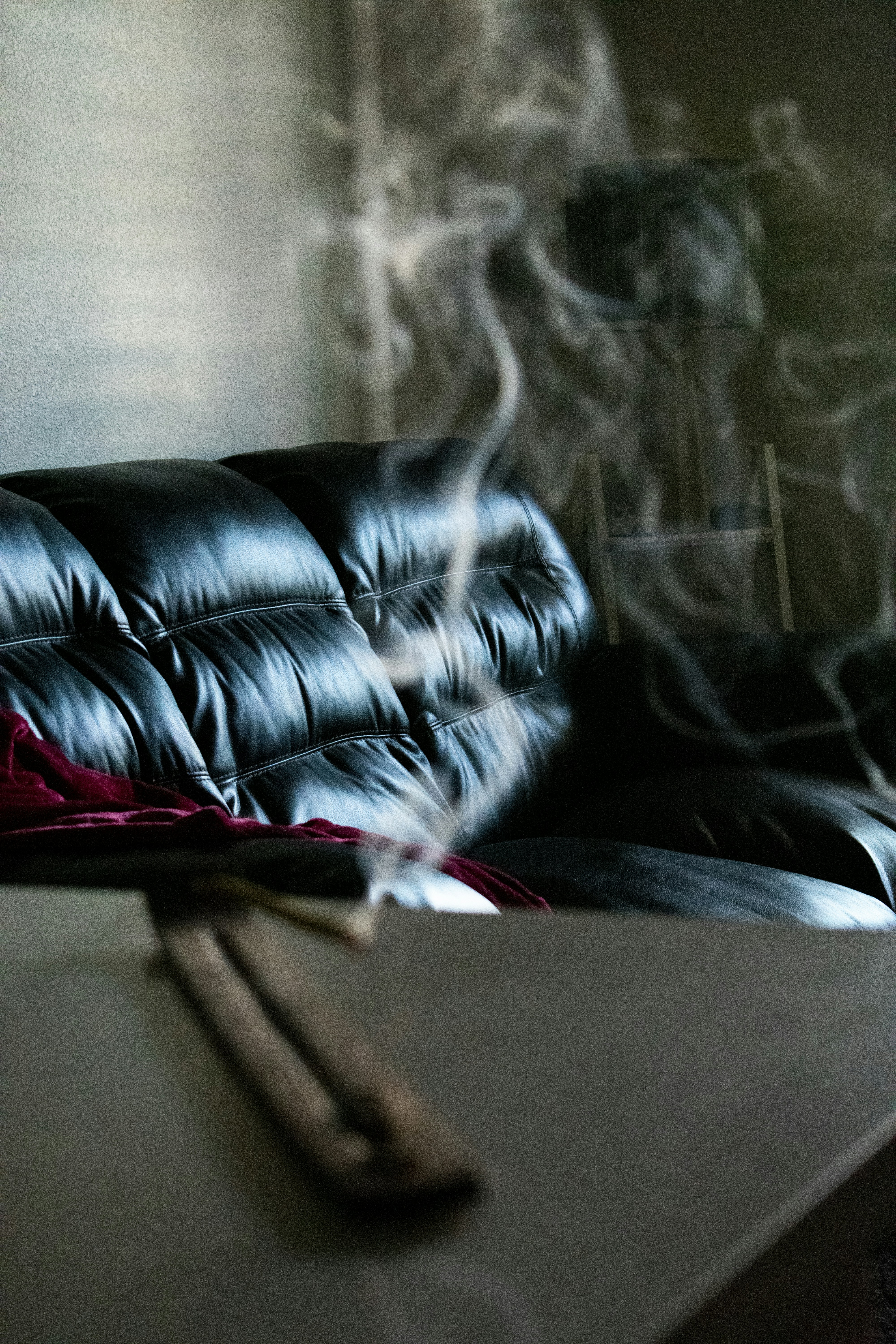 Whispers Over Velvet: Smoke Waving Through a Dim Living Room