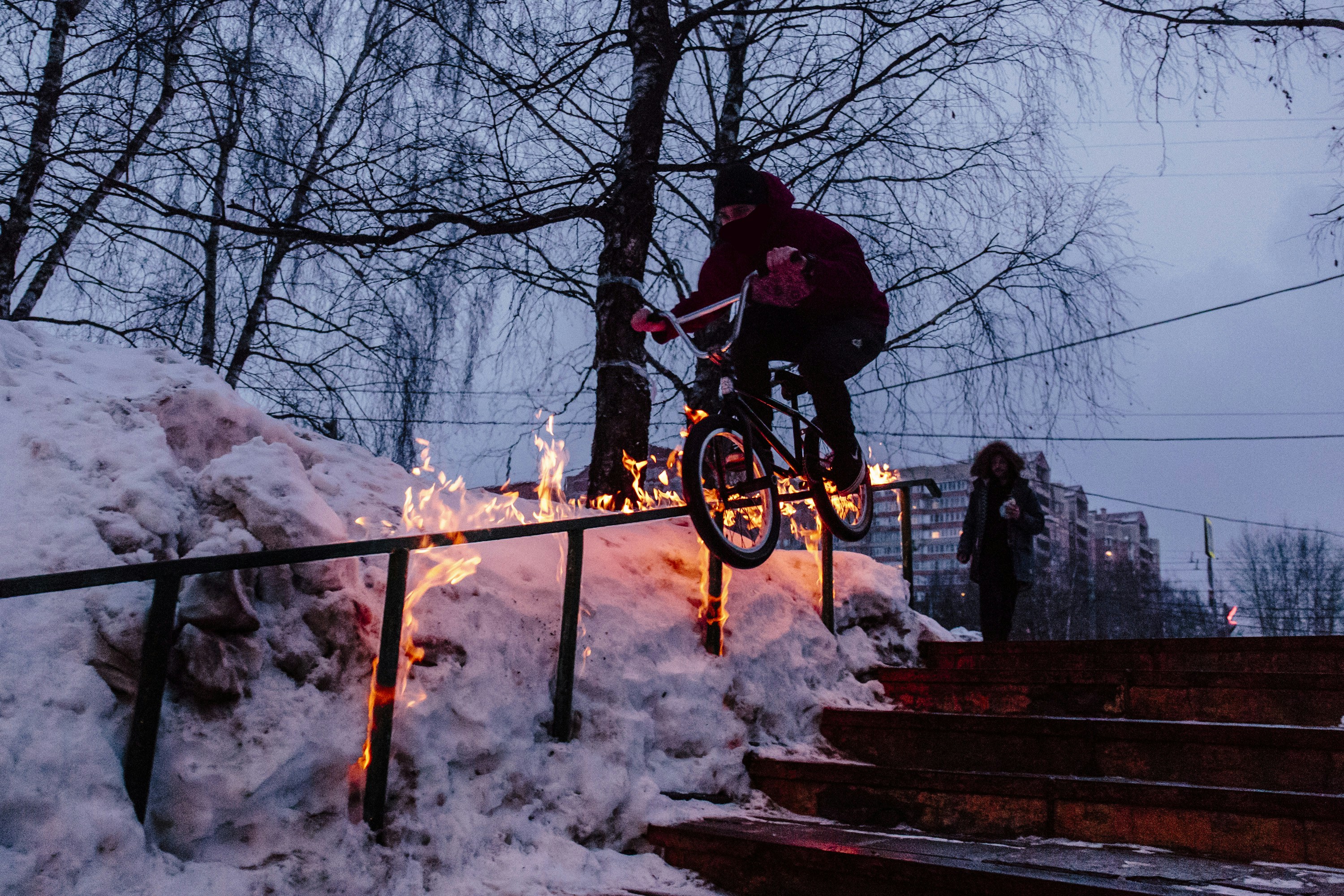 Man doing bicycle tricks on hand rail during winter photo – Free Bike ...
