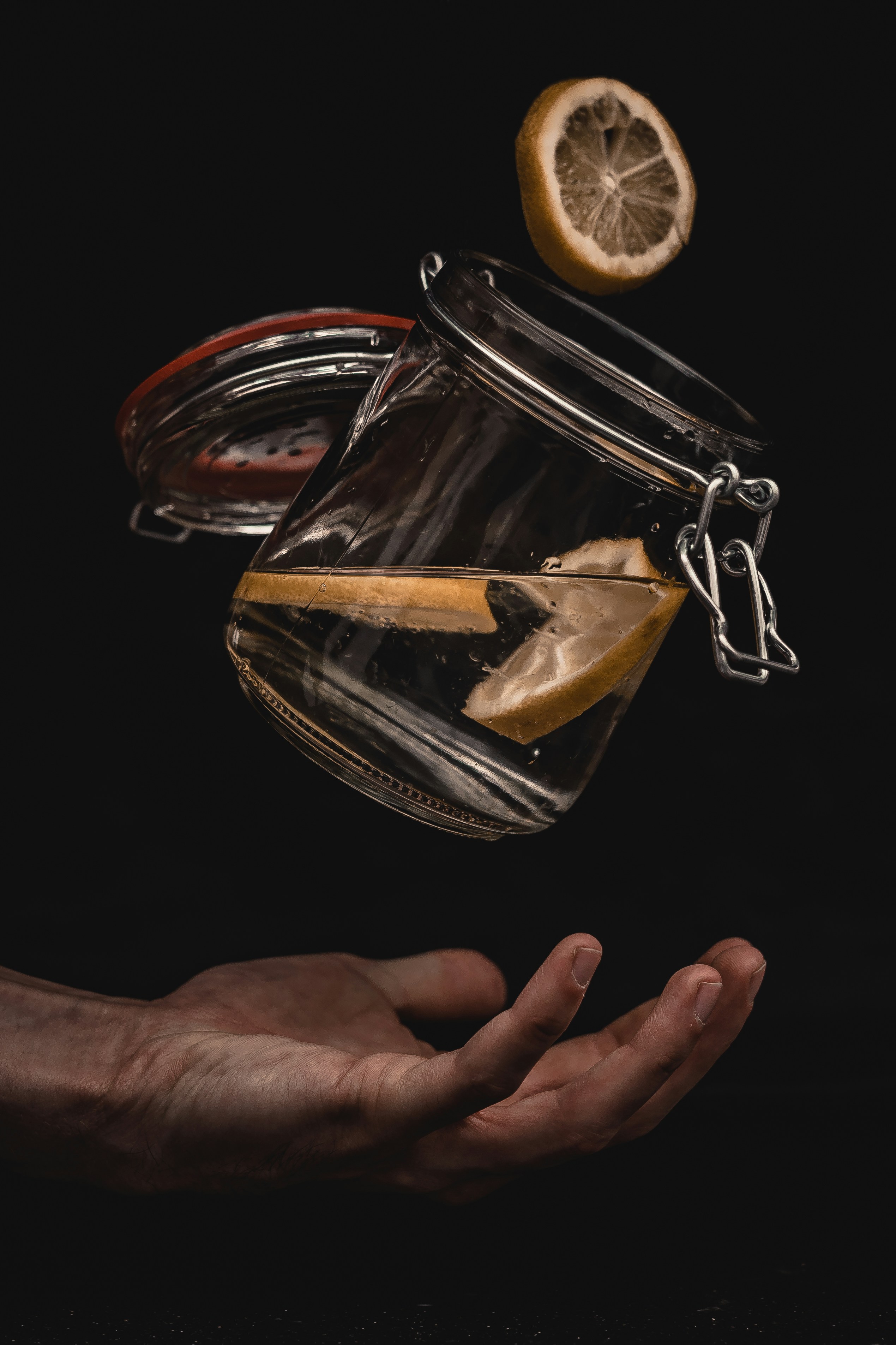 Gravity-Defying Citrus: A Glass Jar Suspends Over an Open Hand