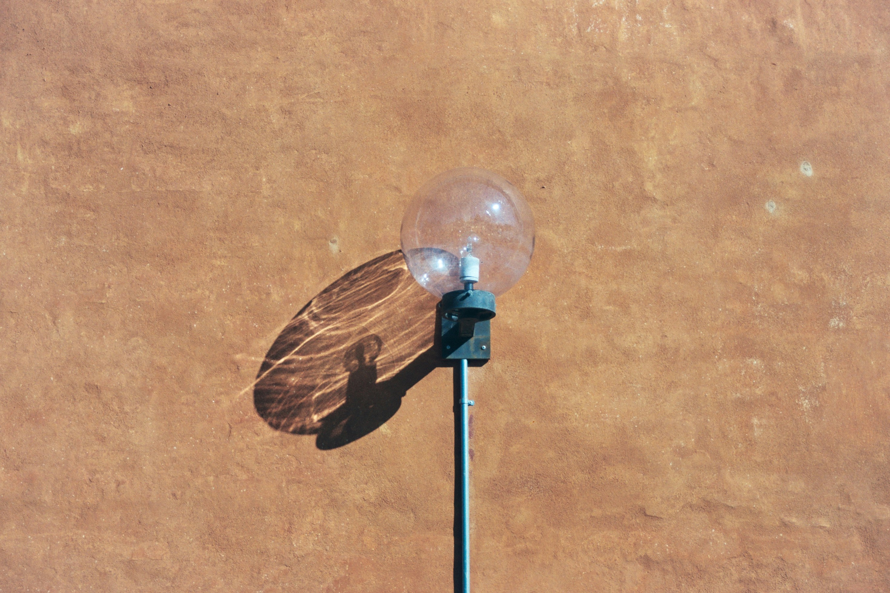 Shadowed Glass Orb on a Quiet Terrace
