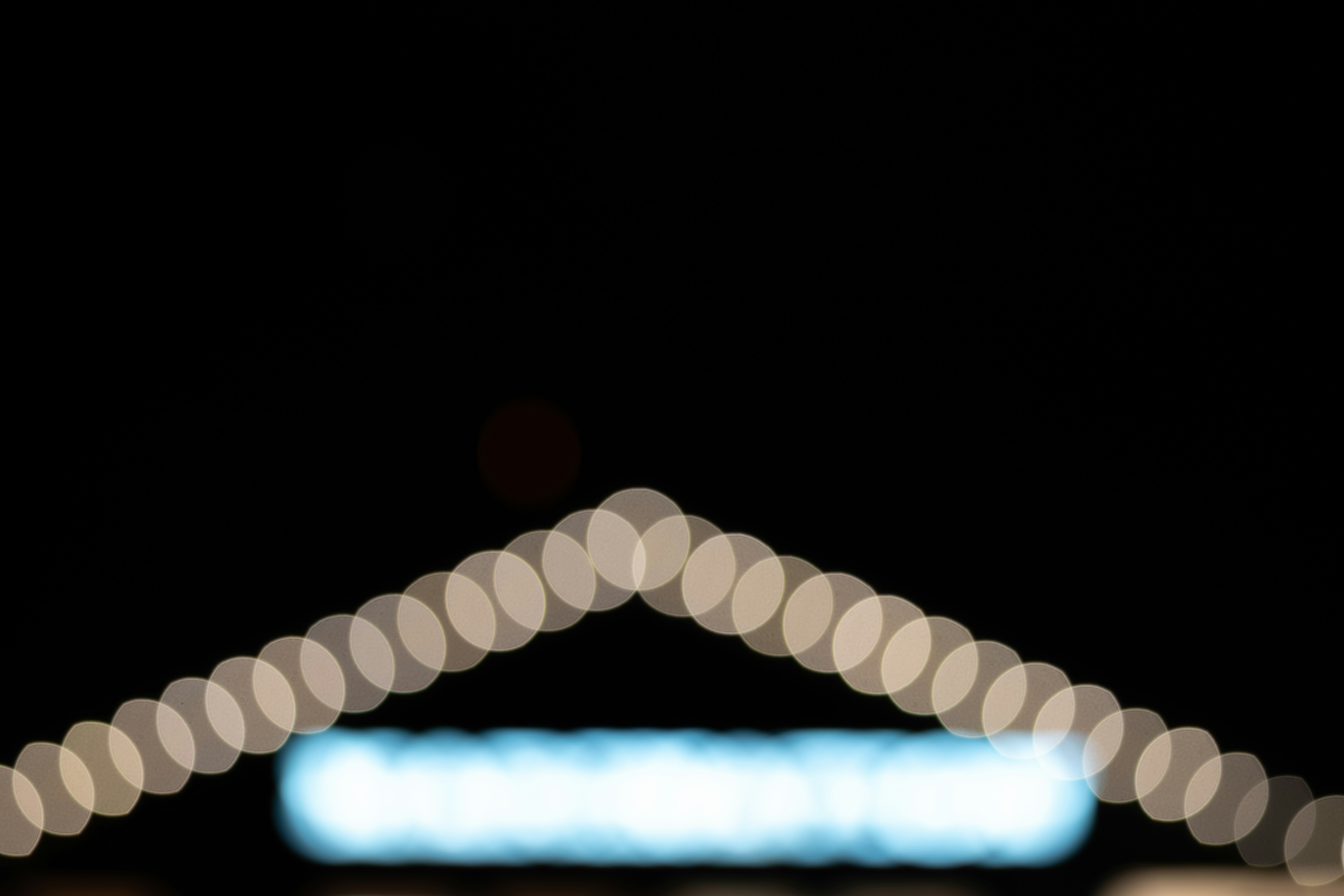 V-arched Orbs: Night Bokeh Over Neon Glow