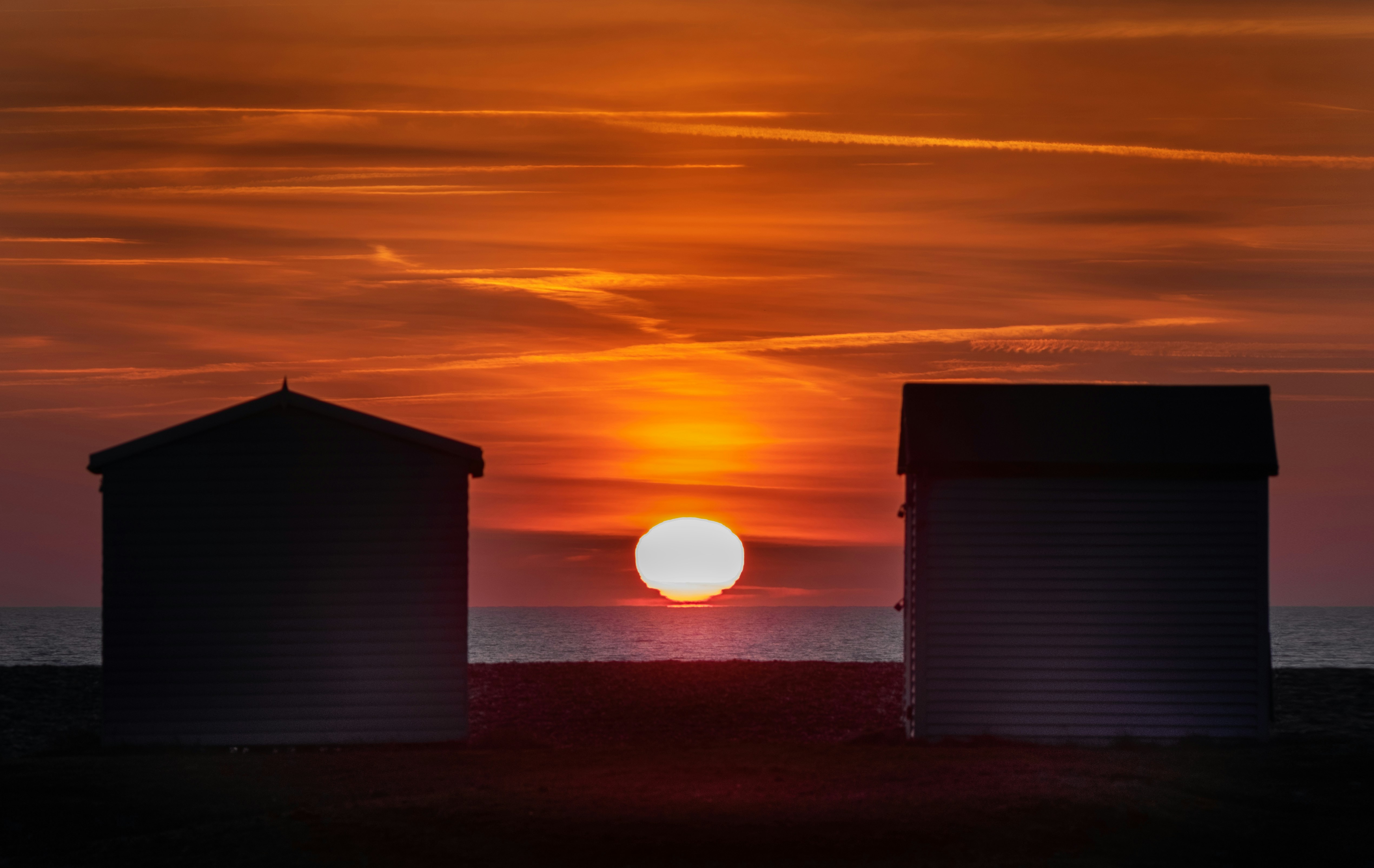Two A-Frame Silhouettes Embrace the Dusk Horizon