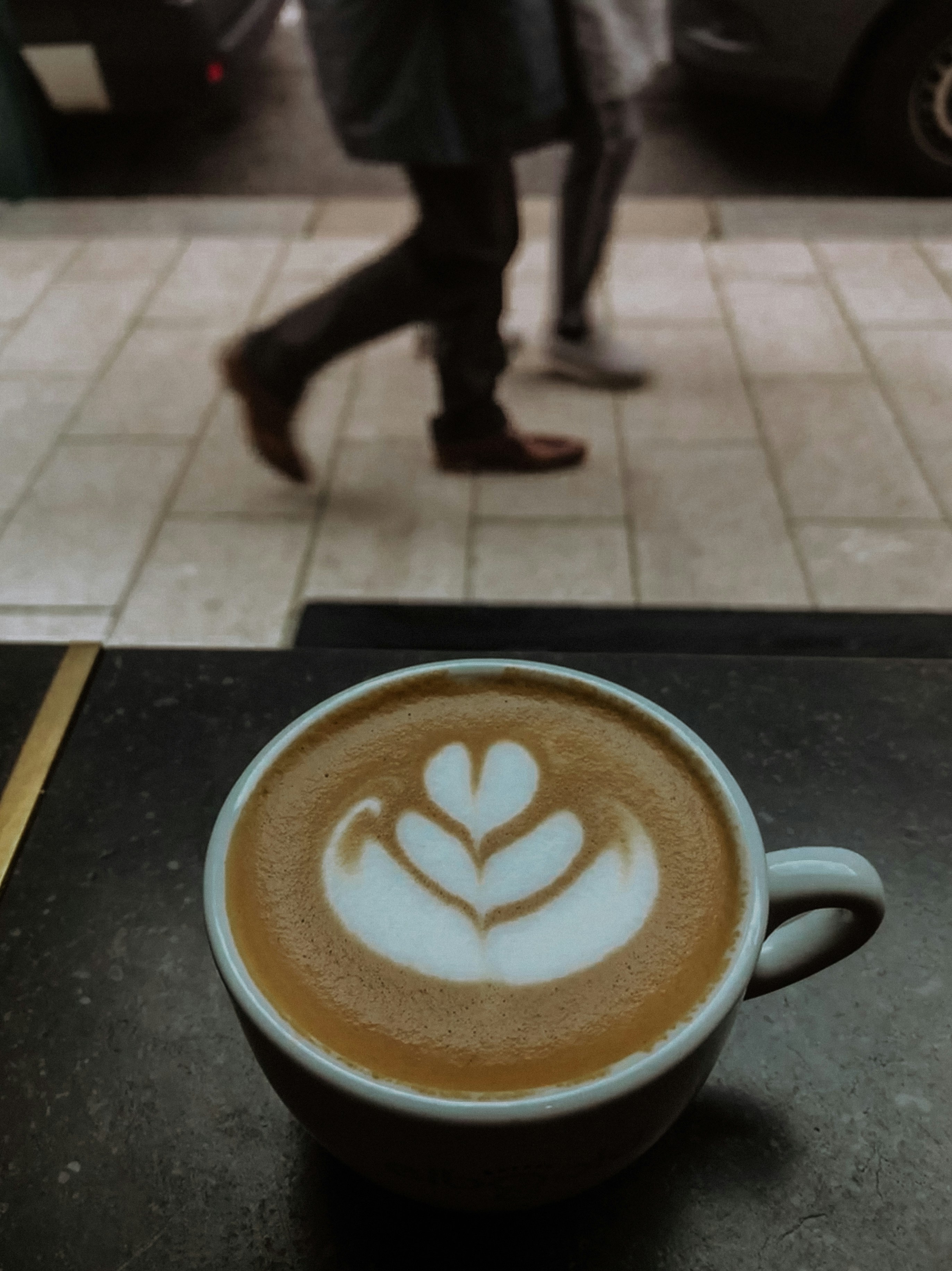 Latte Heart in Focus: Steam, Art, and the Sidewalk Blur
