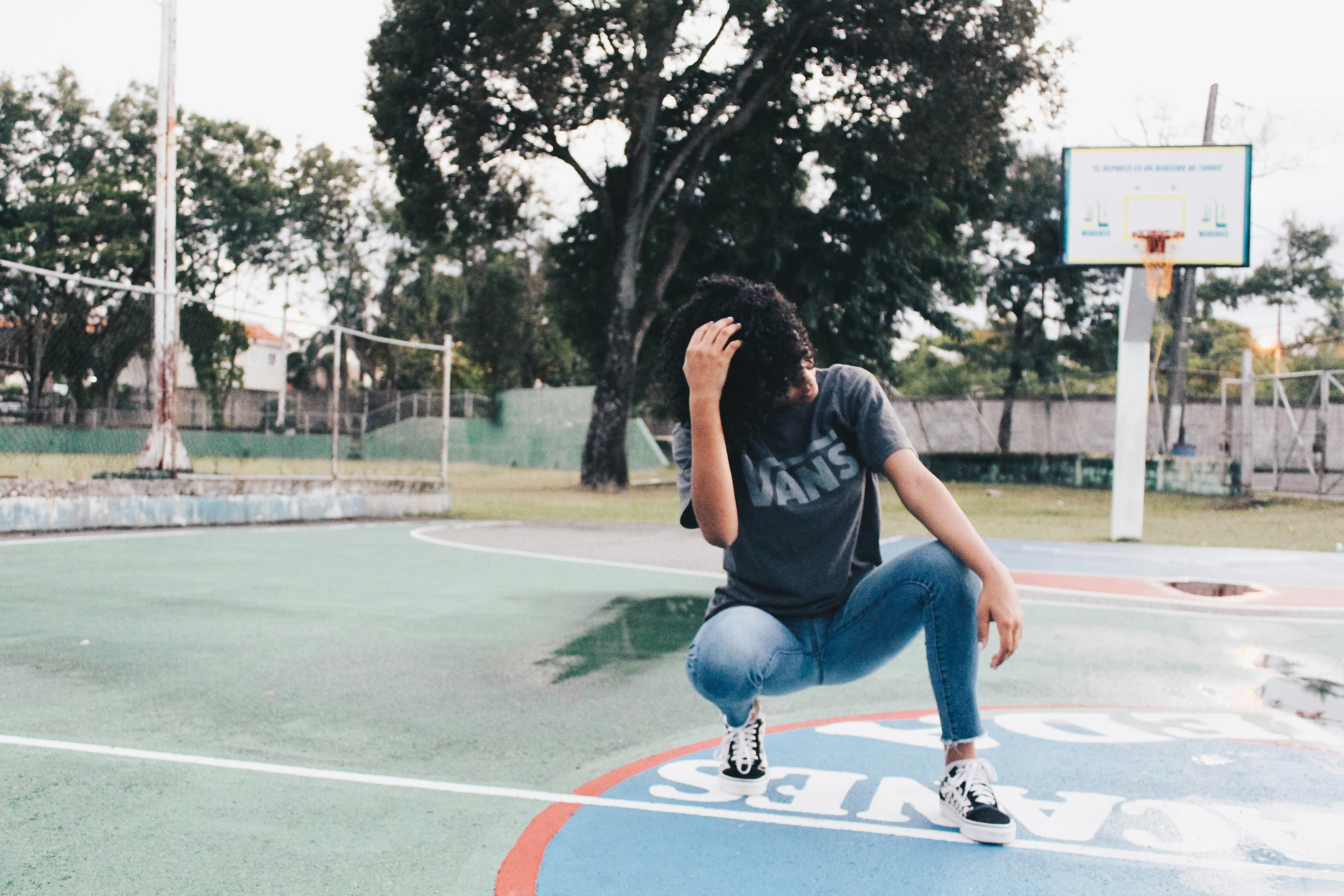 Paused on the Painted Court: A Quiet Moment with a Youth