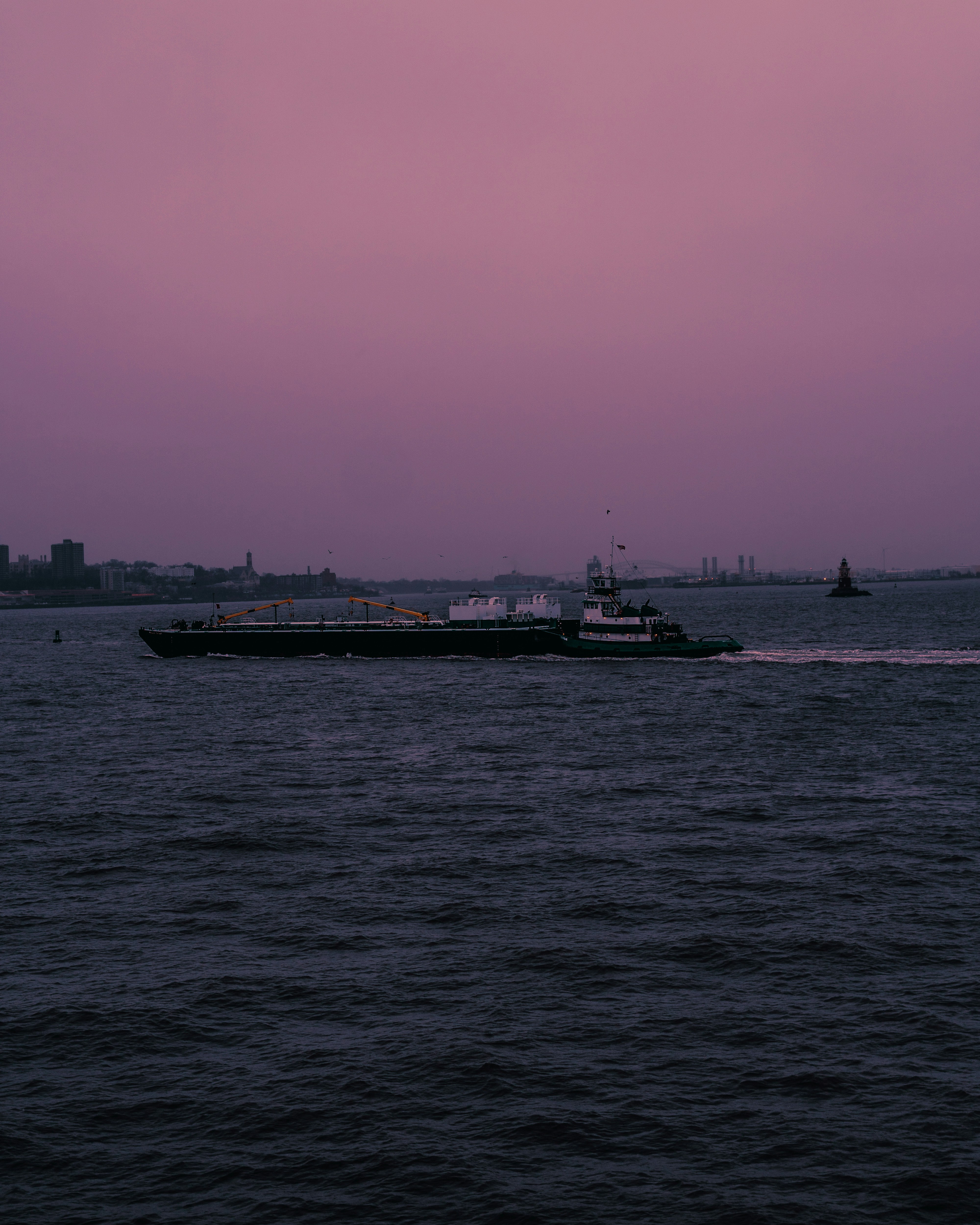 Dusk Freighter Slicing a Pink-Purple Seascape