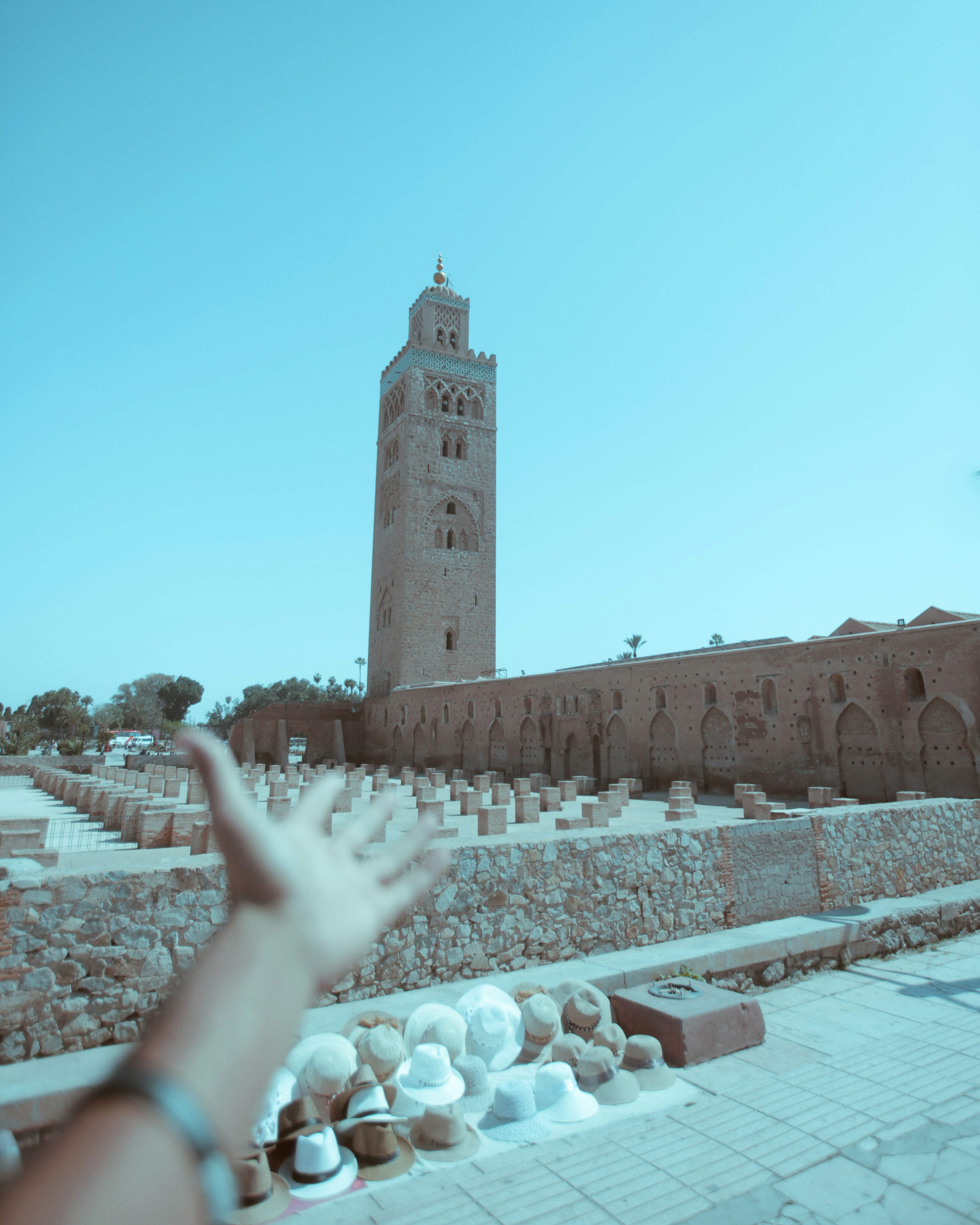 Invitation to the Oasis: A Towering Milestone Over a Courtyard of Hats