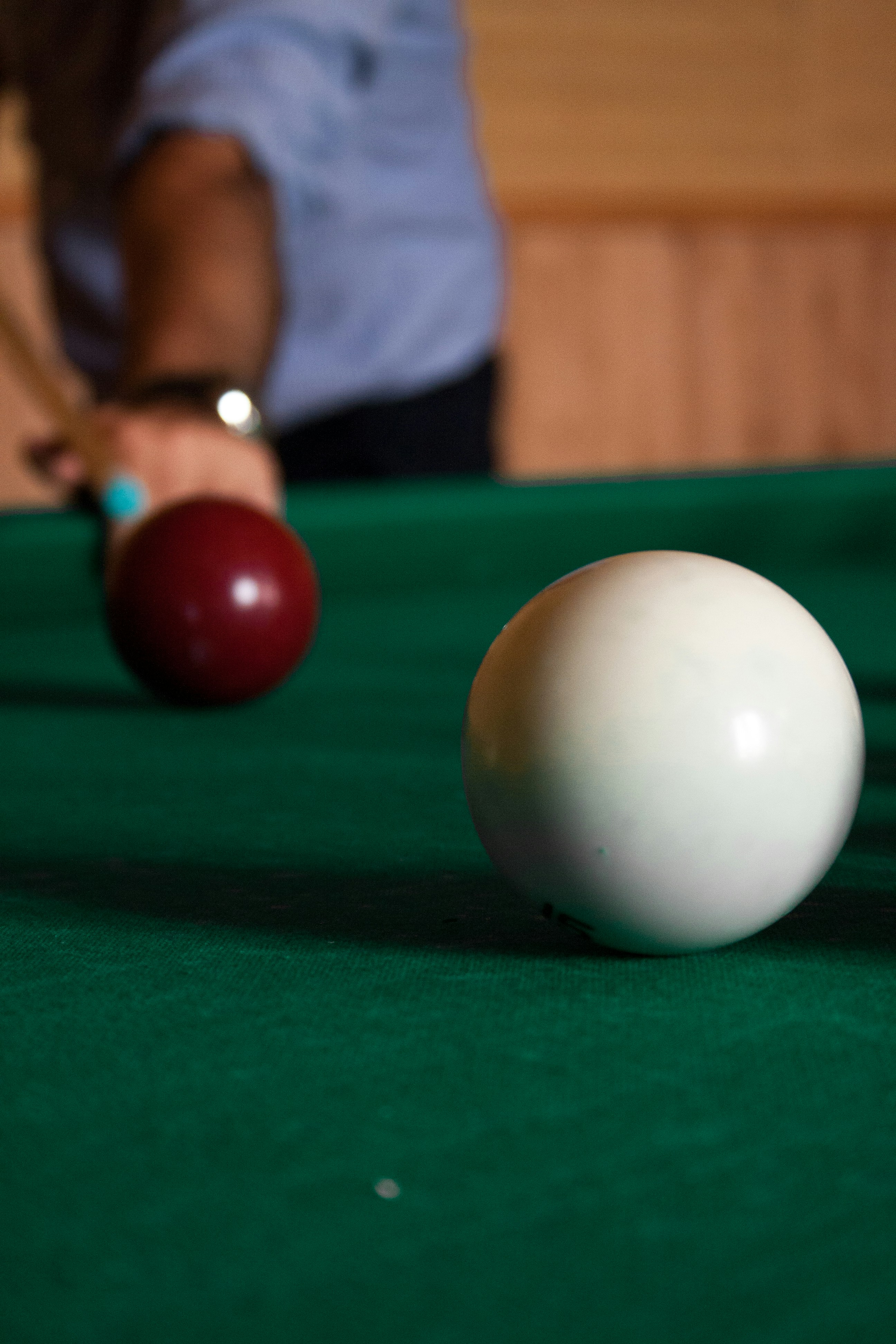 White Cue Ball Leads the Duel on a Green Billiards Table