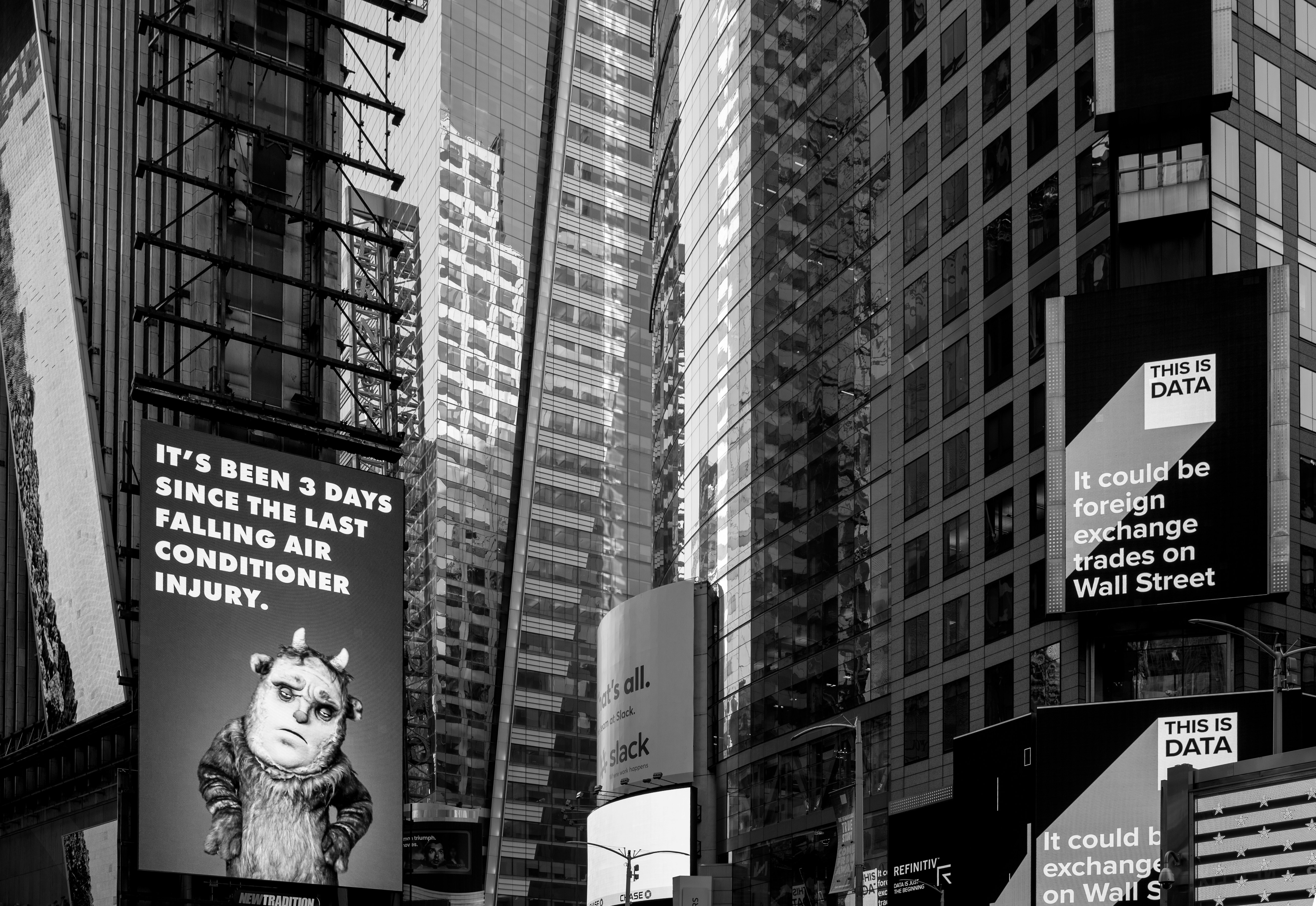 Monochrome Canyon: A Cat Billboard Amid the Concrete Monoliths