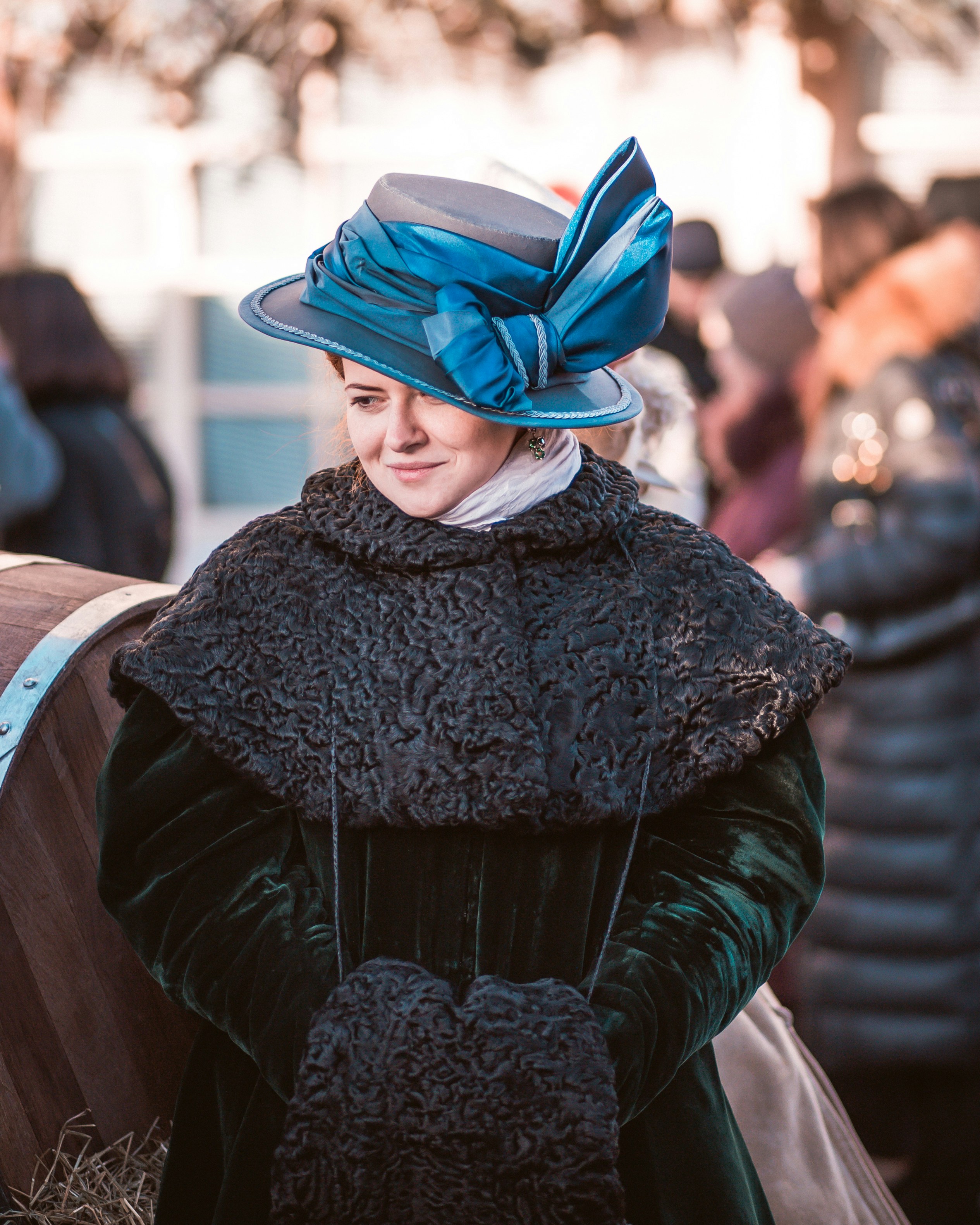 Teal Velvet and Blue Ribbon: A Quiet Portrait Amid a Winter Market Crowd