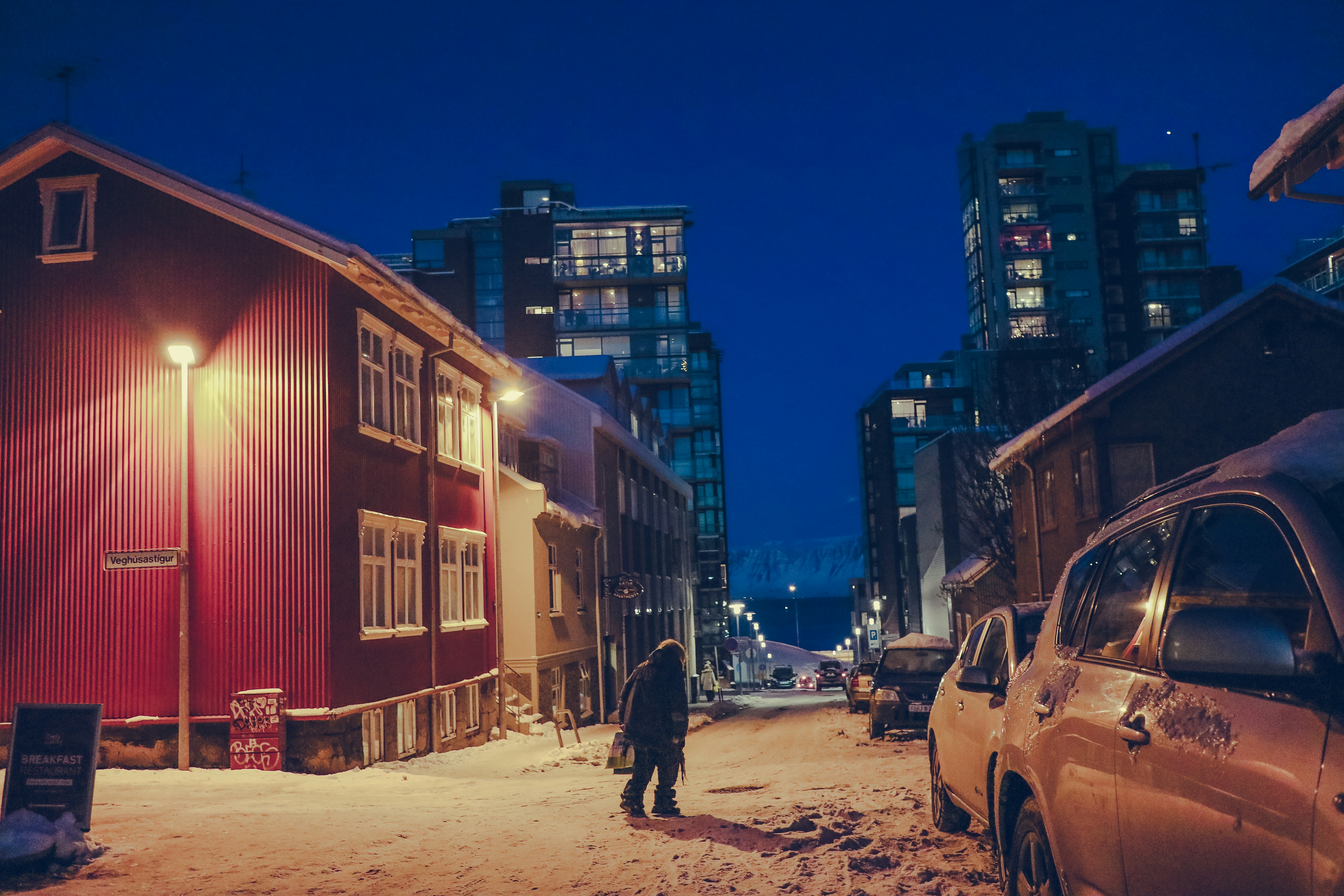 Twilight Stroll through Snowy Urban Alley