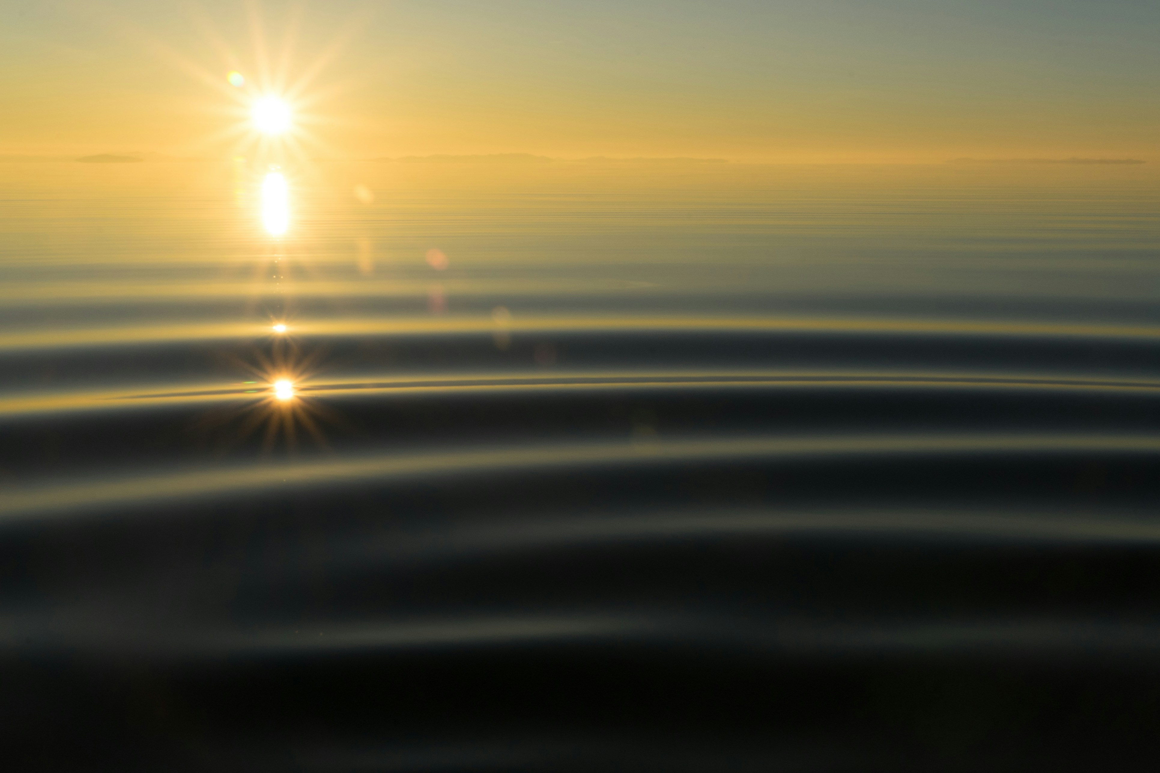 Dawn on Glassy Seas: Light, Ripples, and a Quiet Horizon