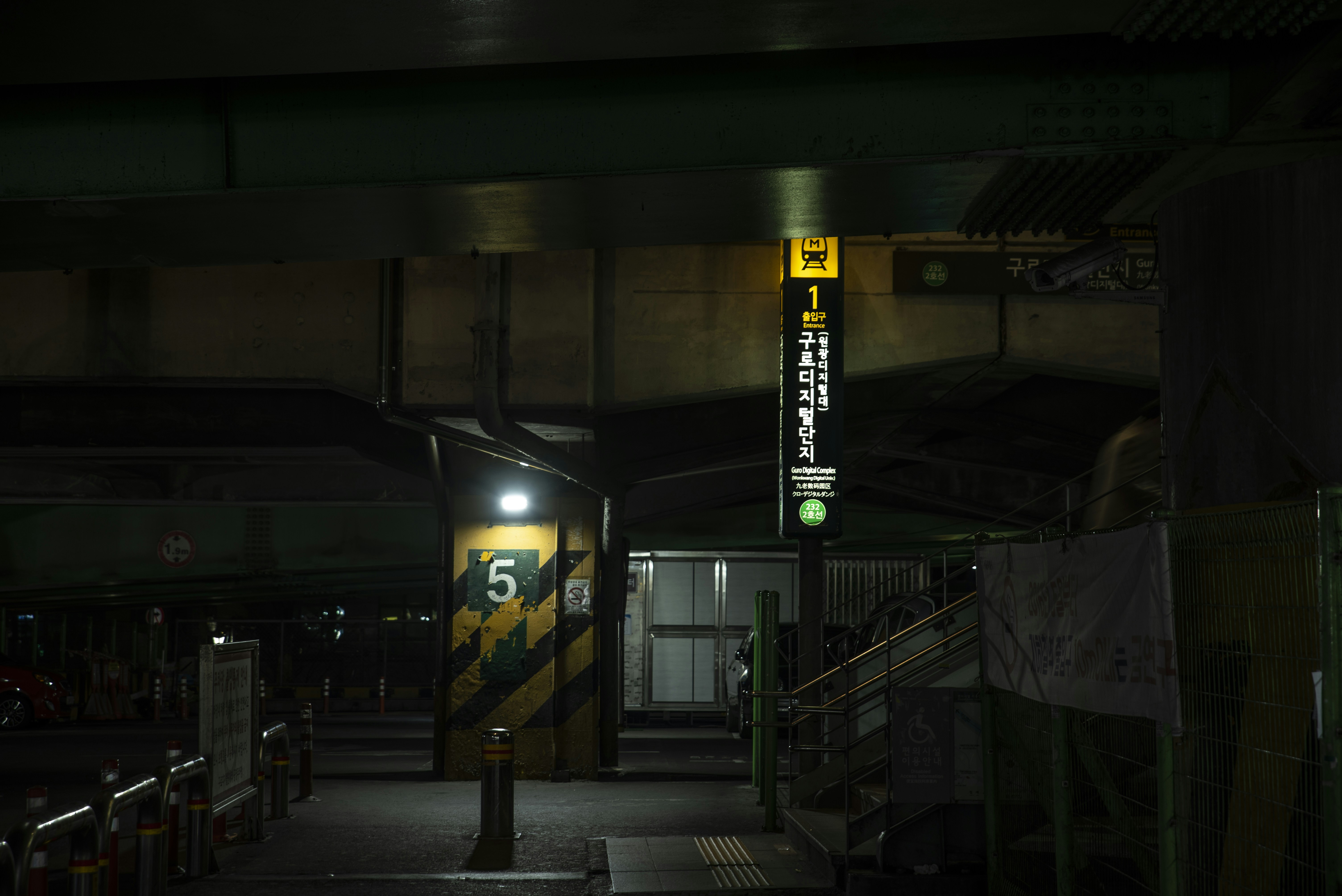 A subway station at night with a lit up sign photo – Free Architecture ...