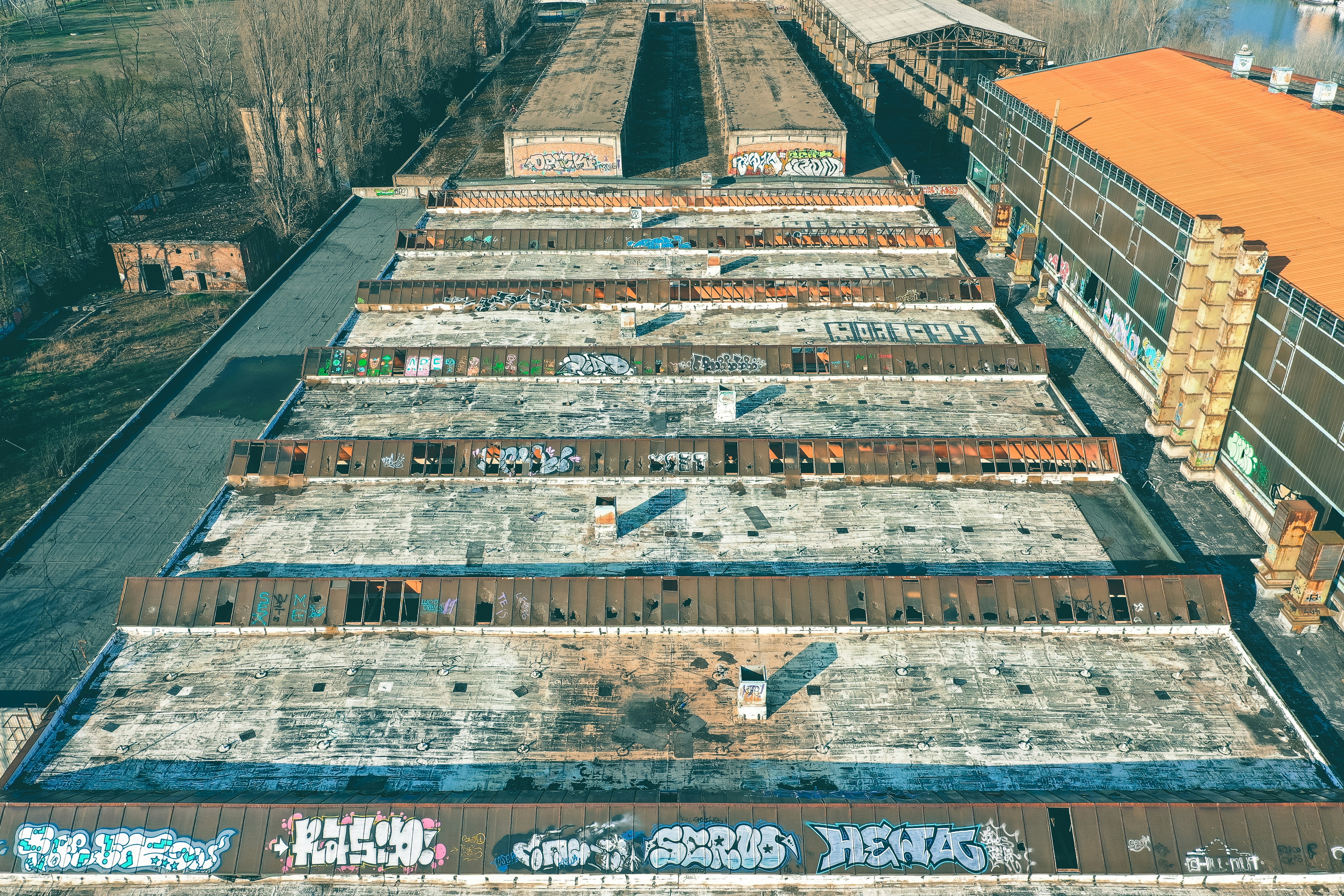 Aerial Graffiti Mosaic: Weathered Freight Cars in an Industrial Yard