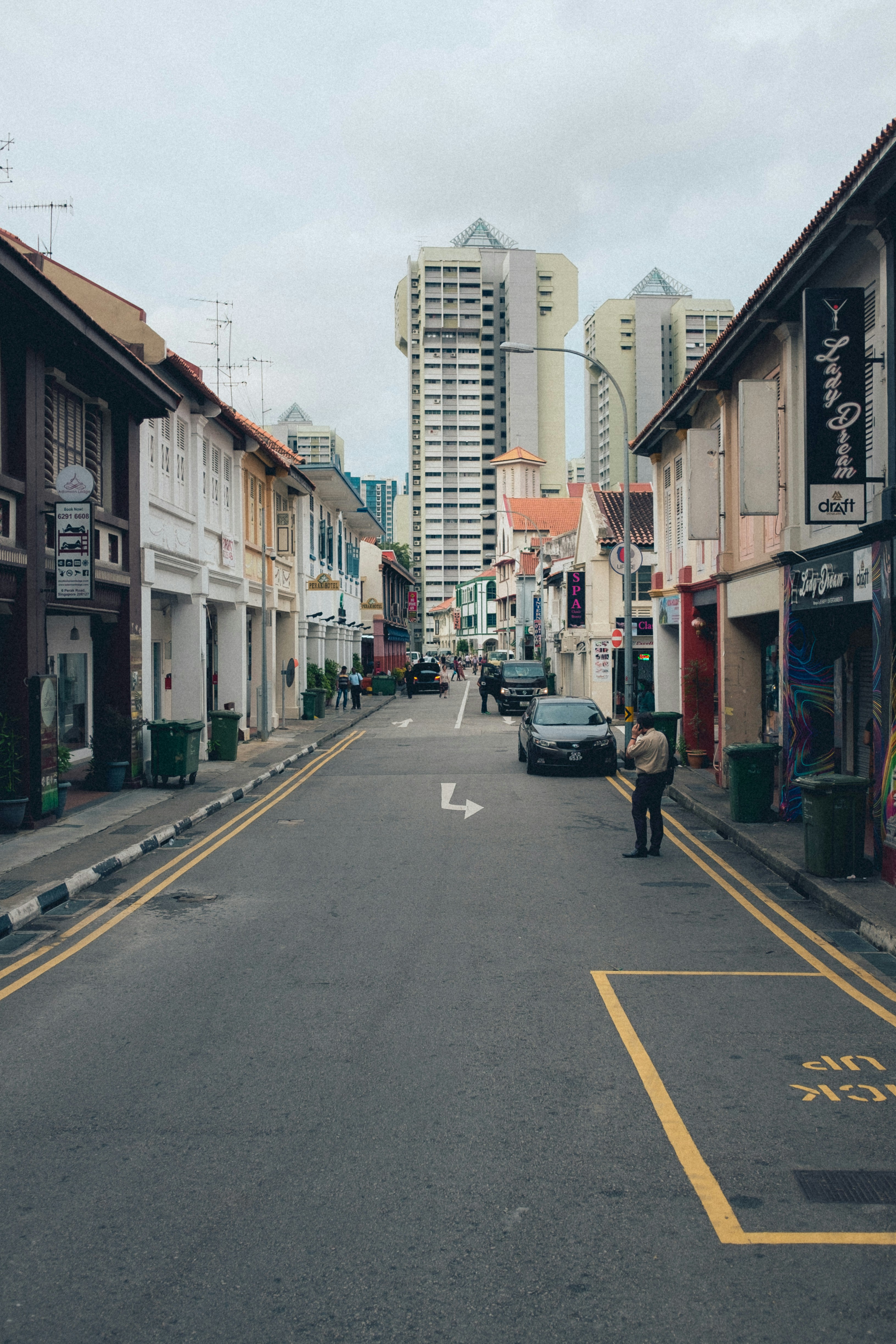 Pastel Promenade: A Quiet Moment on a Shophouse Street