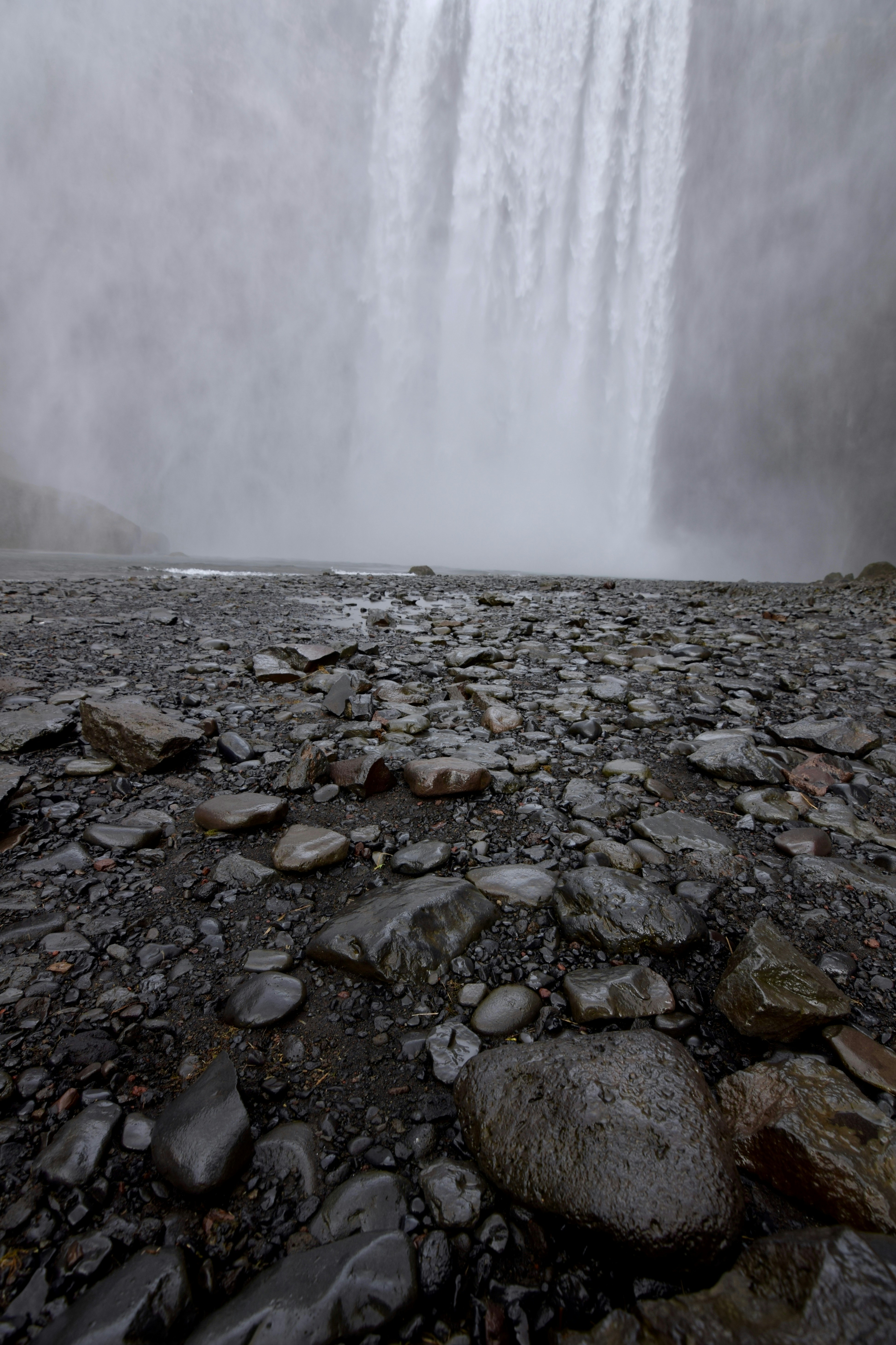 Misty Cascade: Rocks in Foreground, Veil of Waterfall Behind