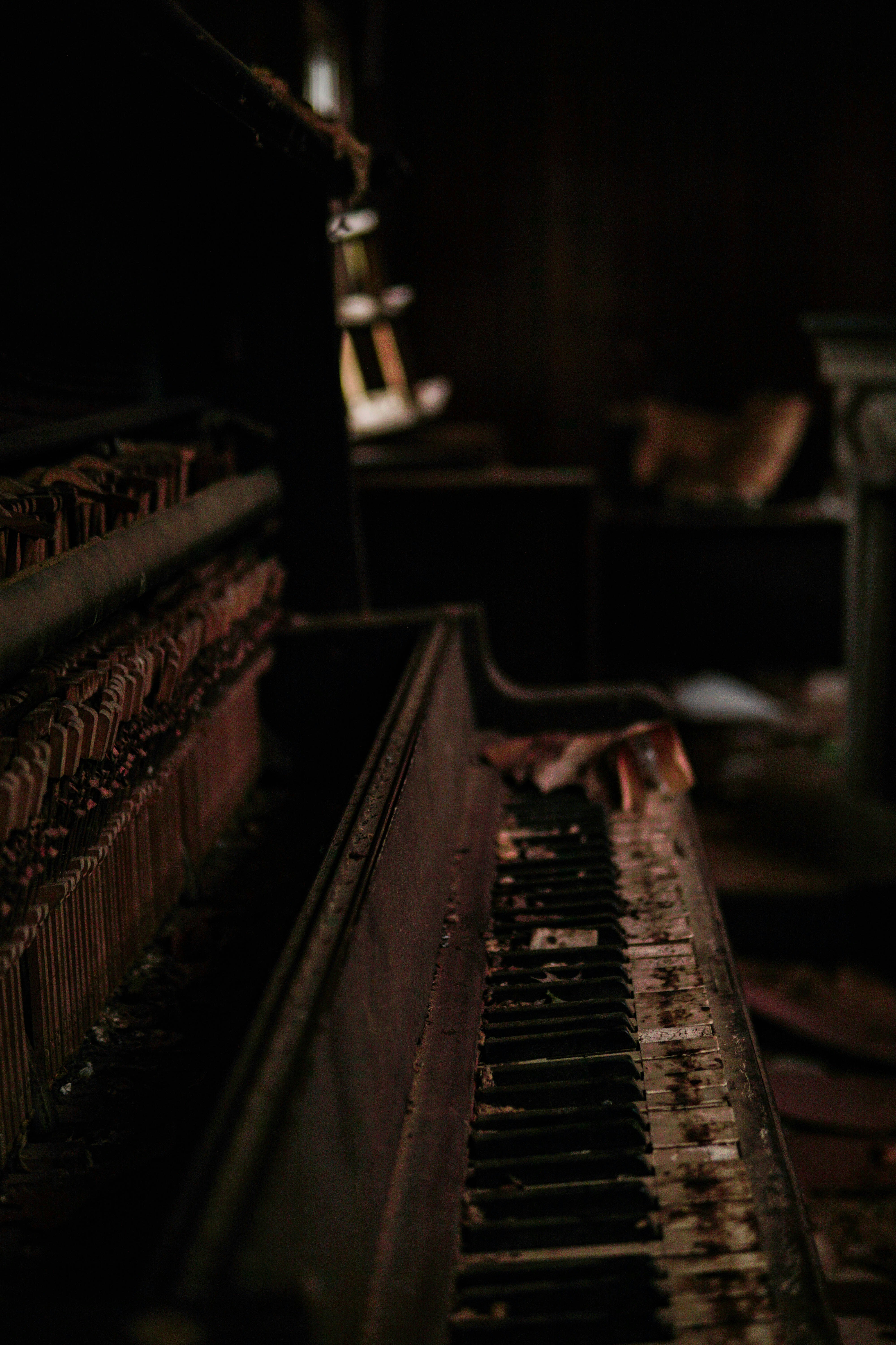 Dust on the Keys: A Dimly Lit Piano in a Ruined Room