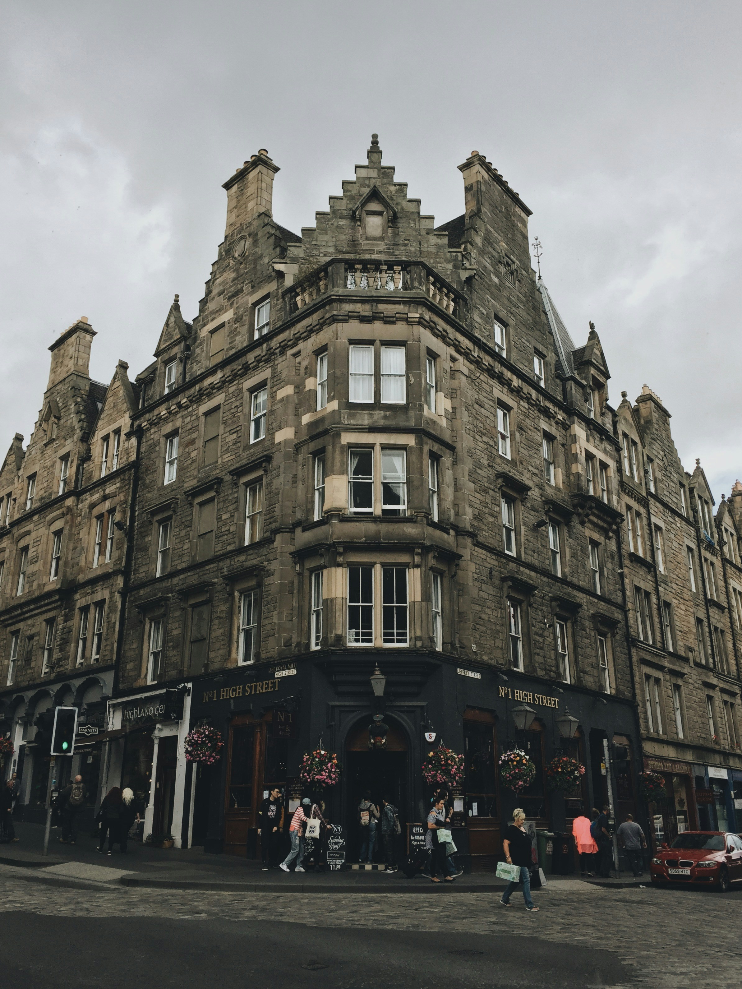 Historic building at the intersection of High Street, showcasing intricate architectural details and bustling street life.