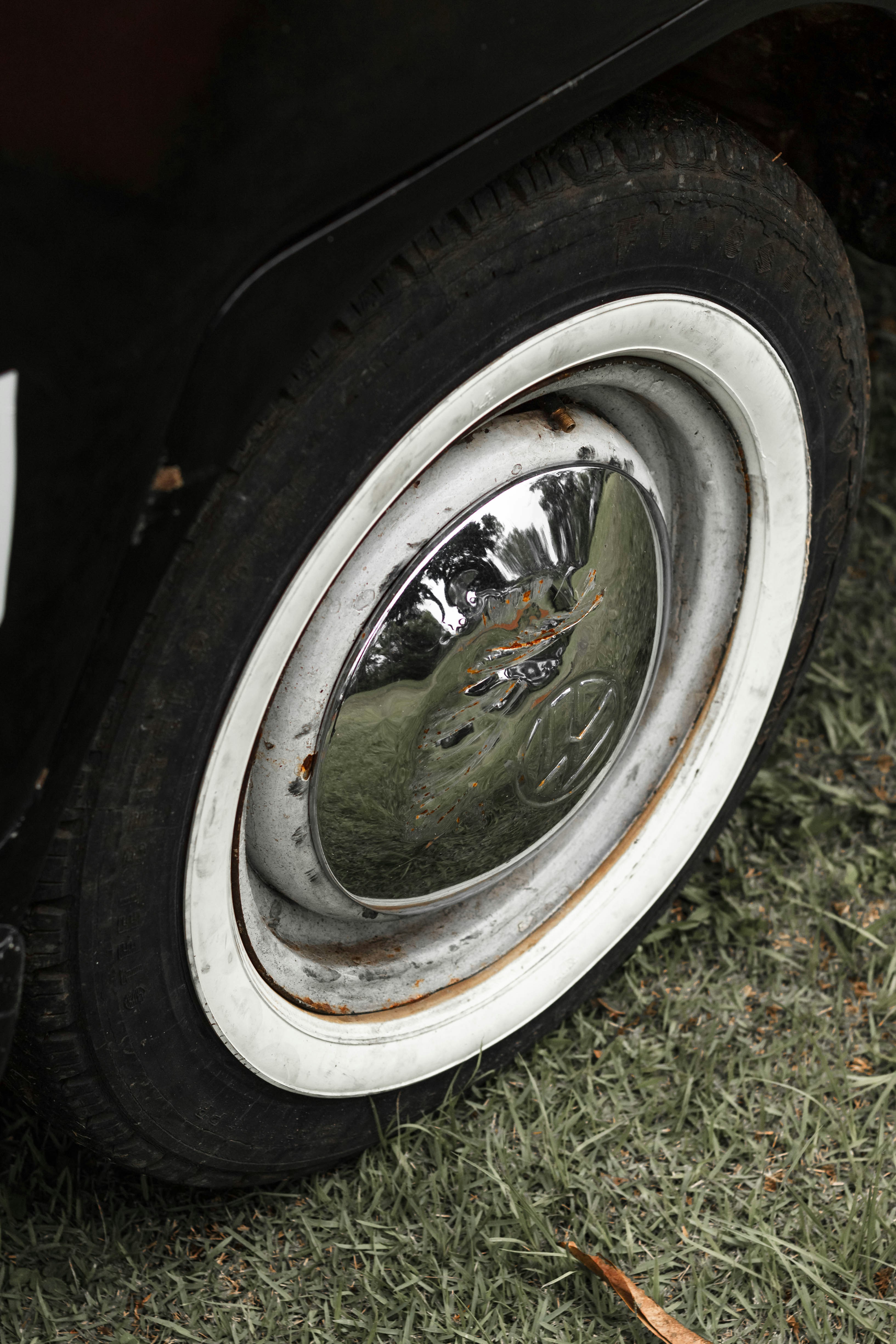 Vintage Hubcap Mirror: A Quiet Glance at a Weathered Wheel
